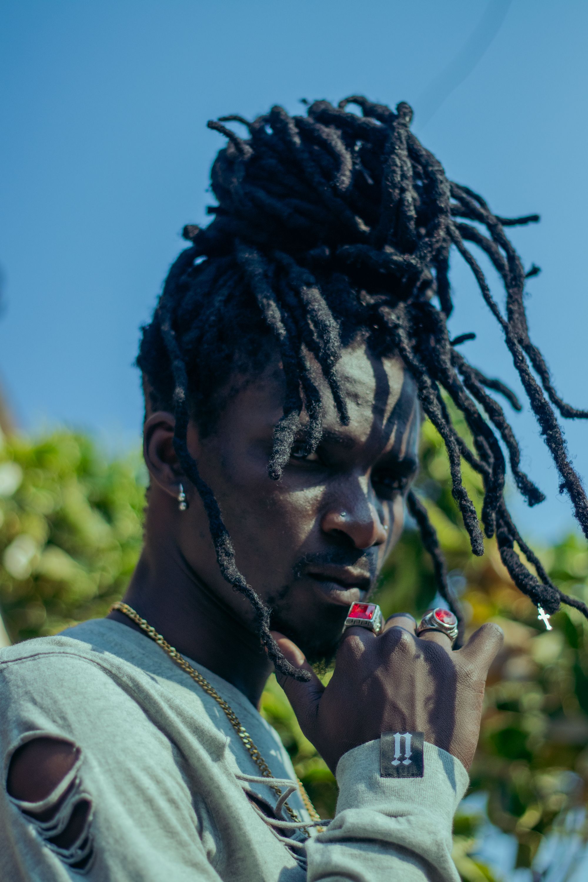 Stylish Man with Dreadlocks Under Blue Sky · Free Stock Photo