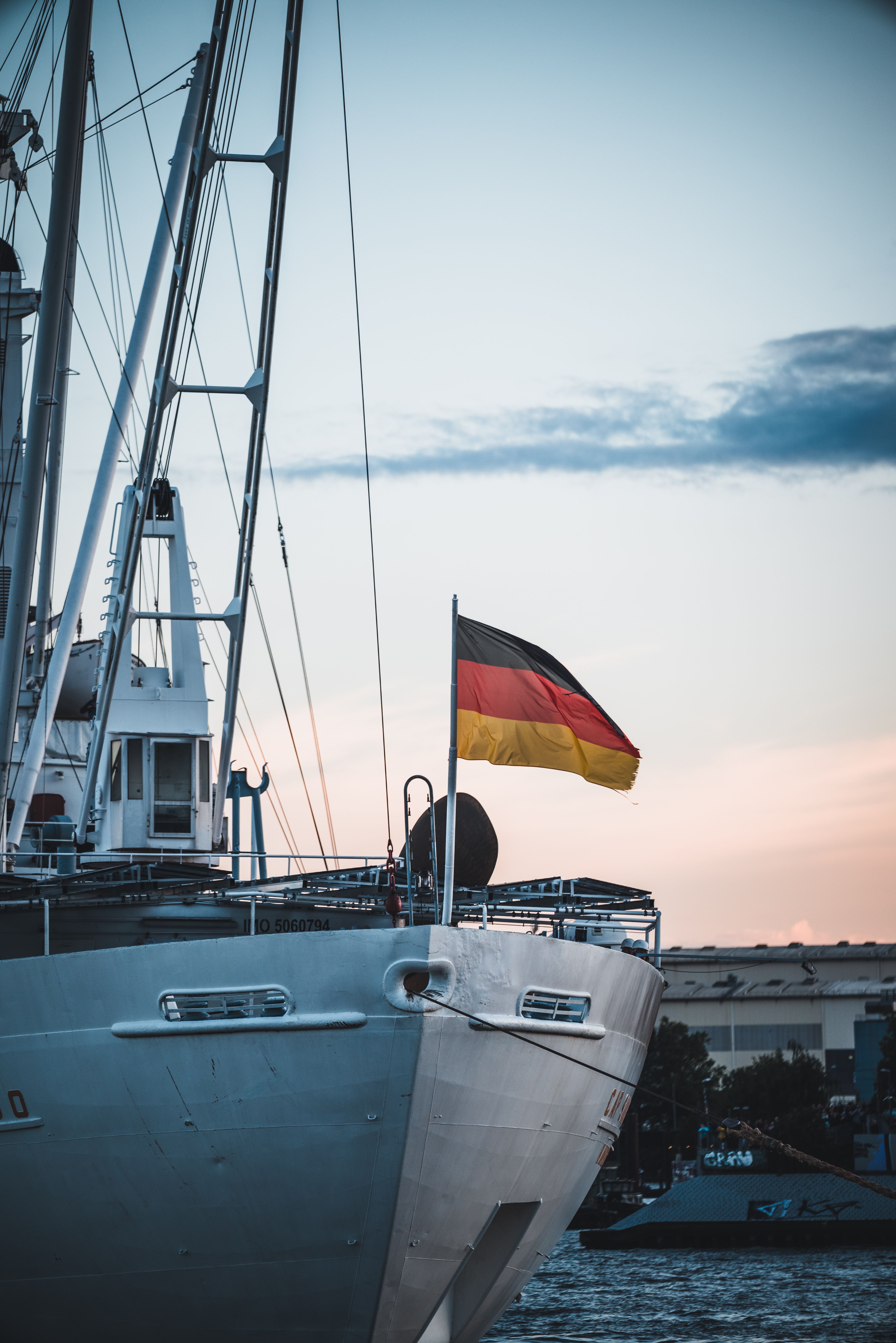 German Flag on Ship at Sunset in Harbor View · Free Stock Photo