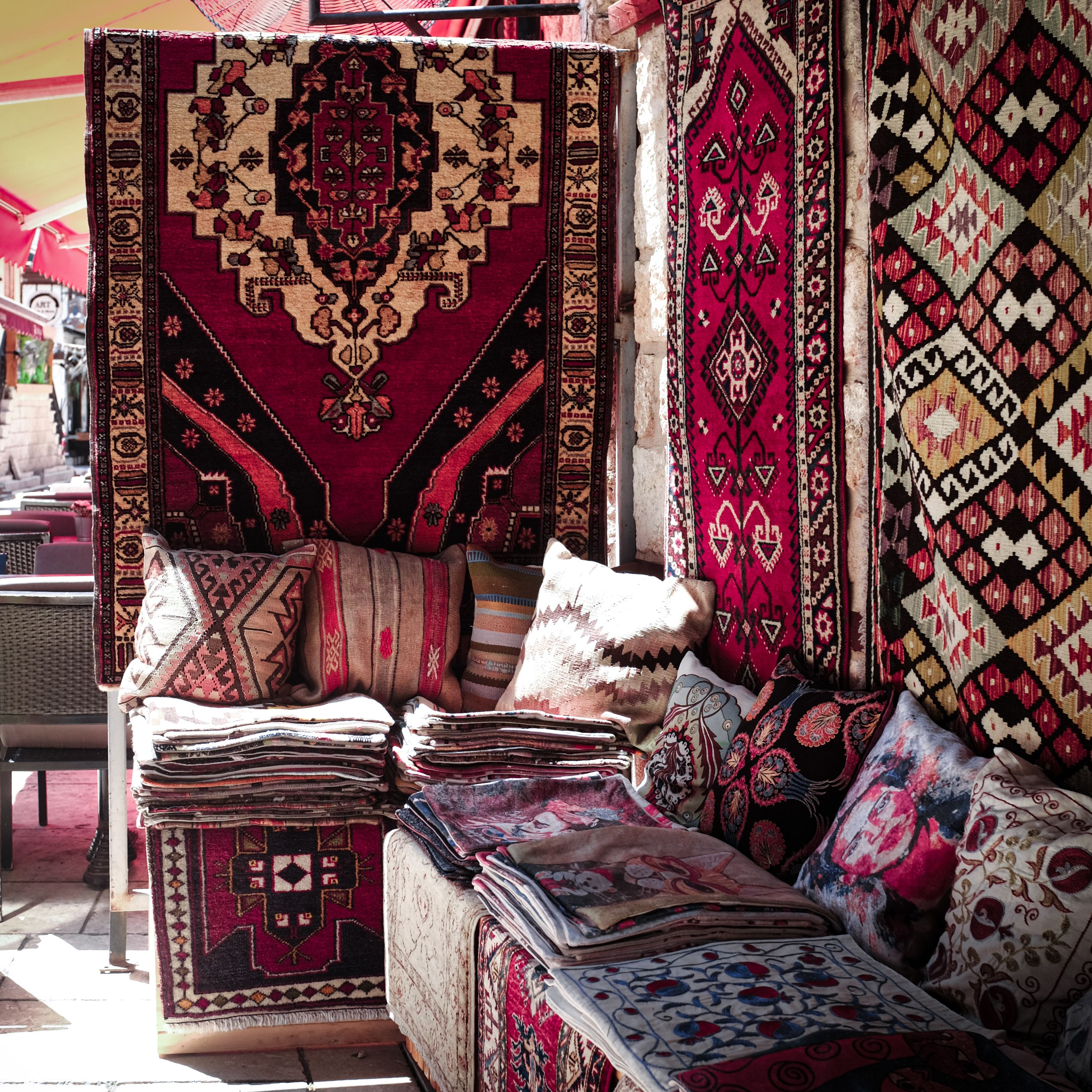 Colorful Display of Traditional Middle Eastern Rugs · Free Stock Photo