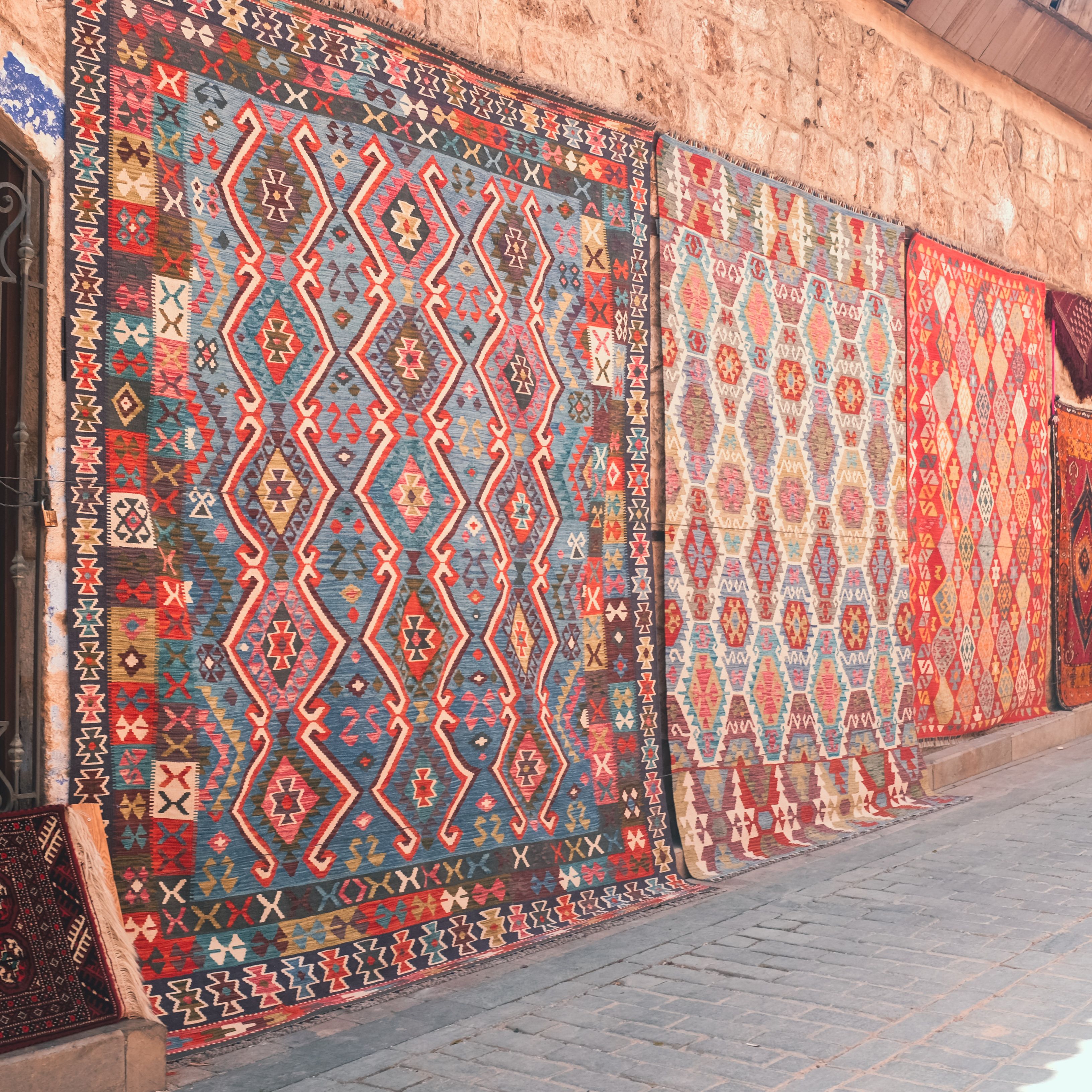 Vibrant Traditional Rugs on Display Outdoors · Free Stock Photo
