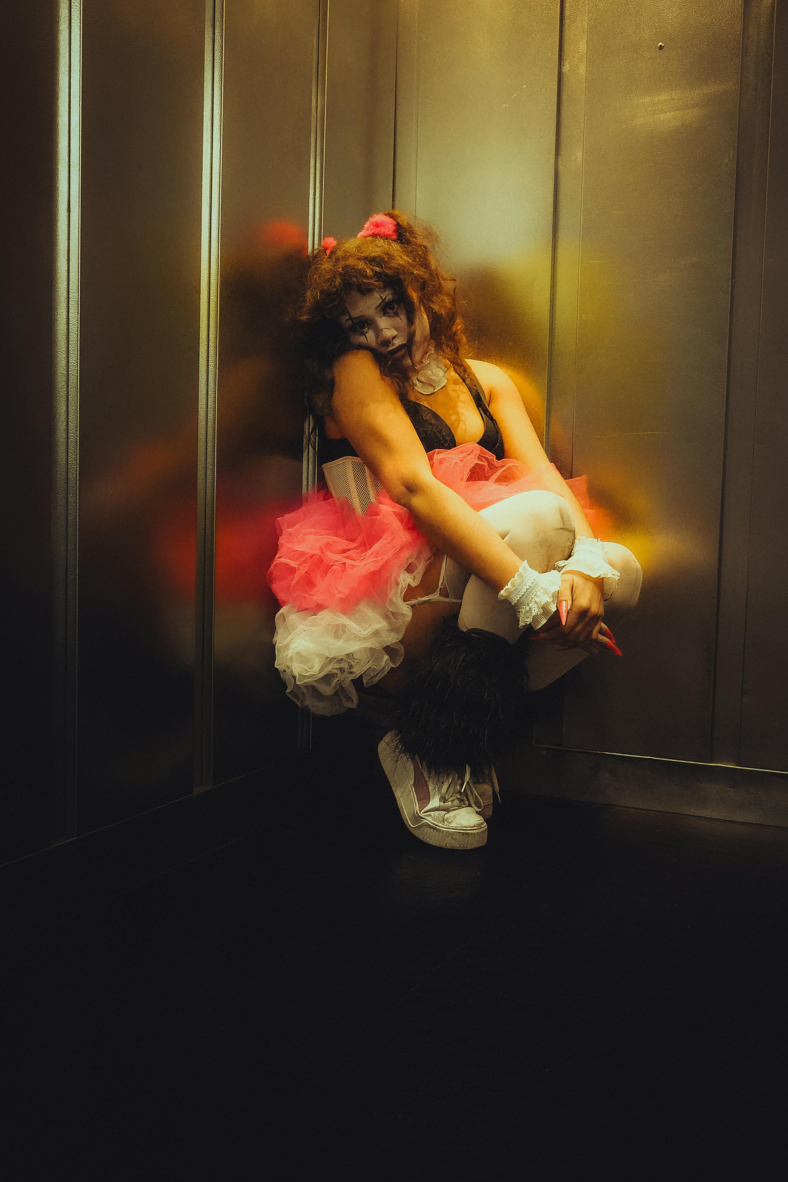 Creepy Gothic Clown in a Dimly Lit Elevator · Free Stock Photo
