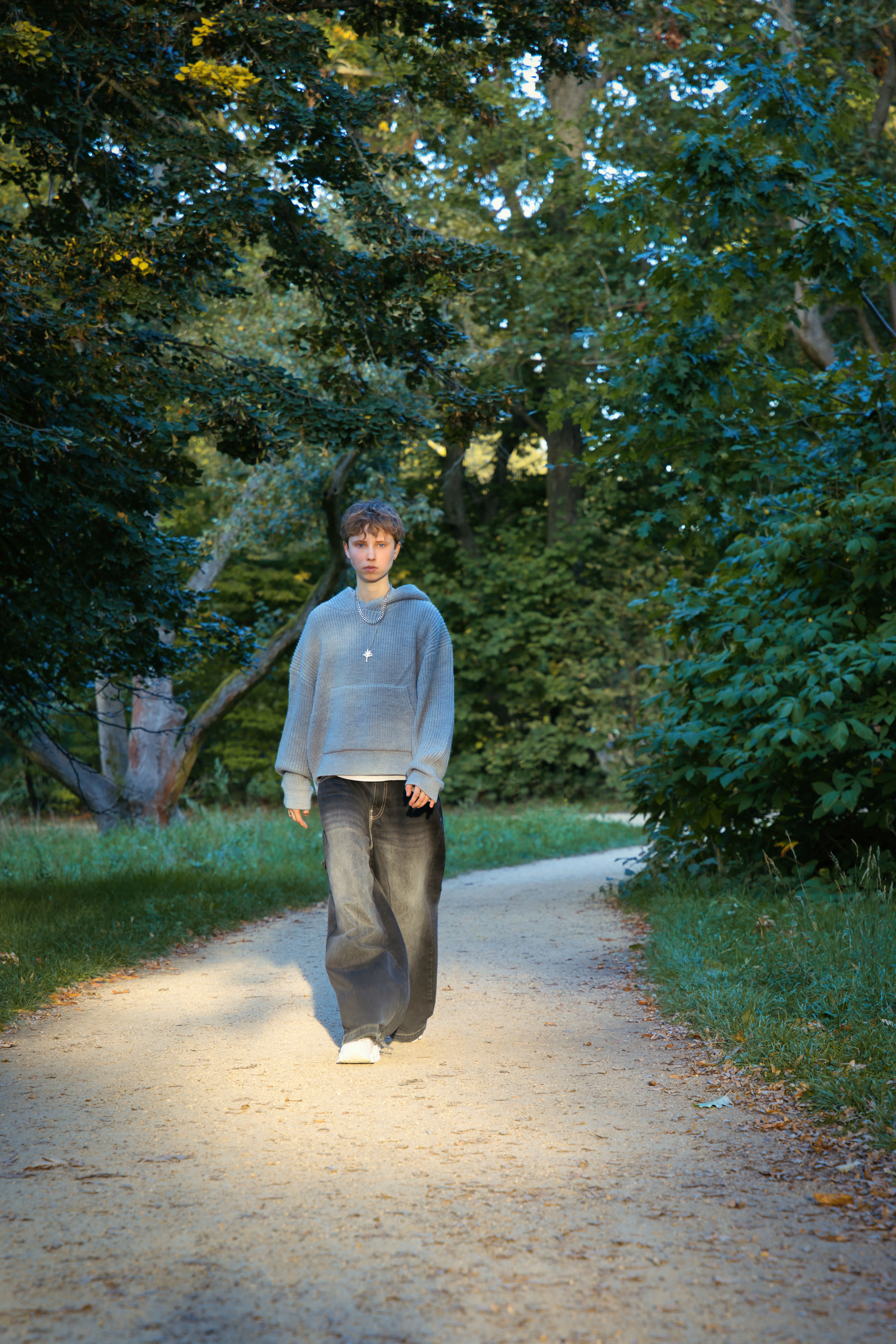 Young Adult Walking in Berlin Park Pathway · Free Stock Photo