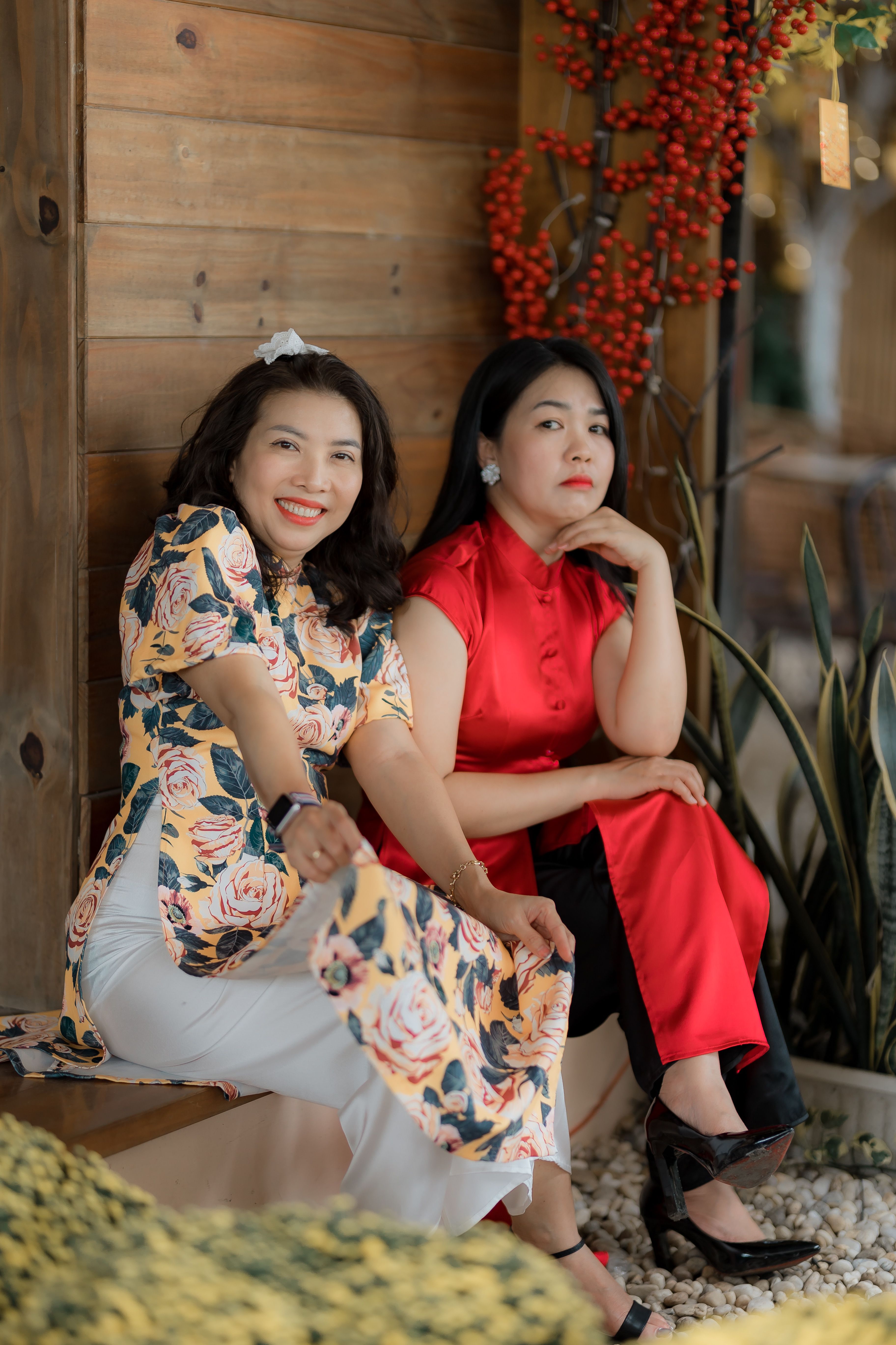 Two Women in Traditional Dresses Sitting on a Bench · Free Stock Photo