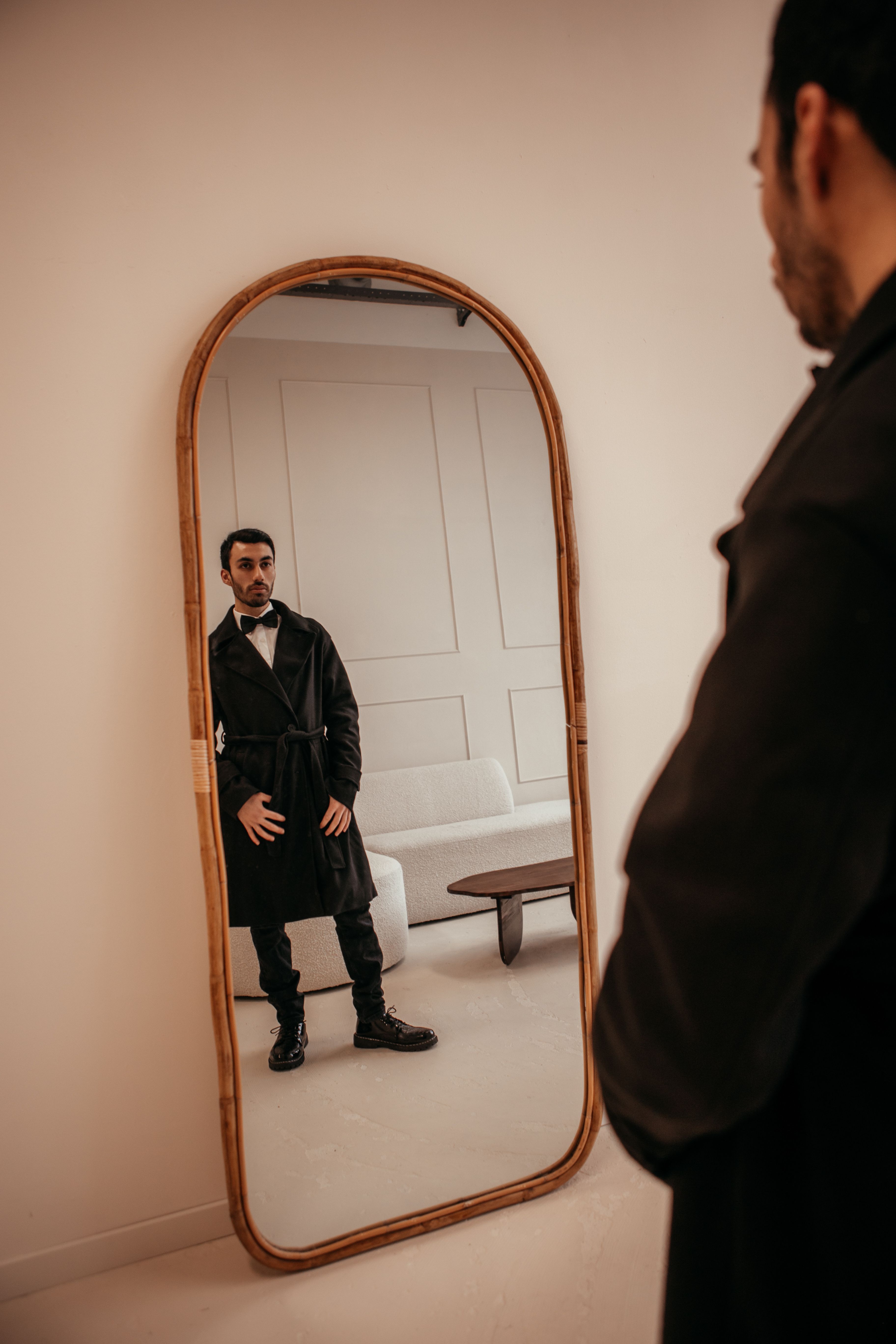 Elegant Man Reflecting in Full-Length Mirror · Free Stock Photo
