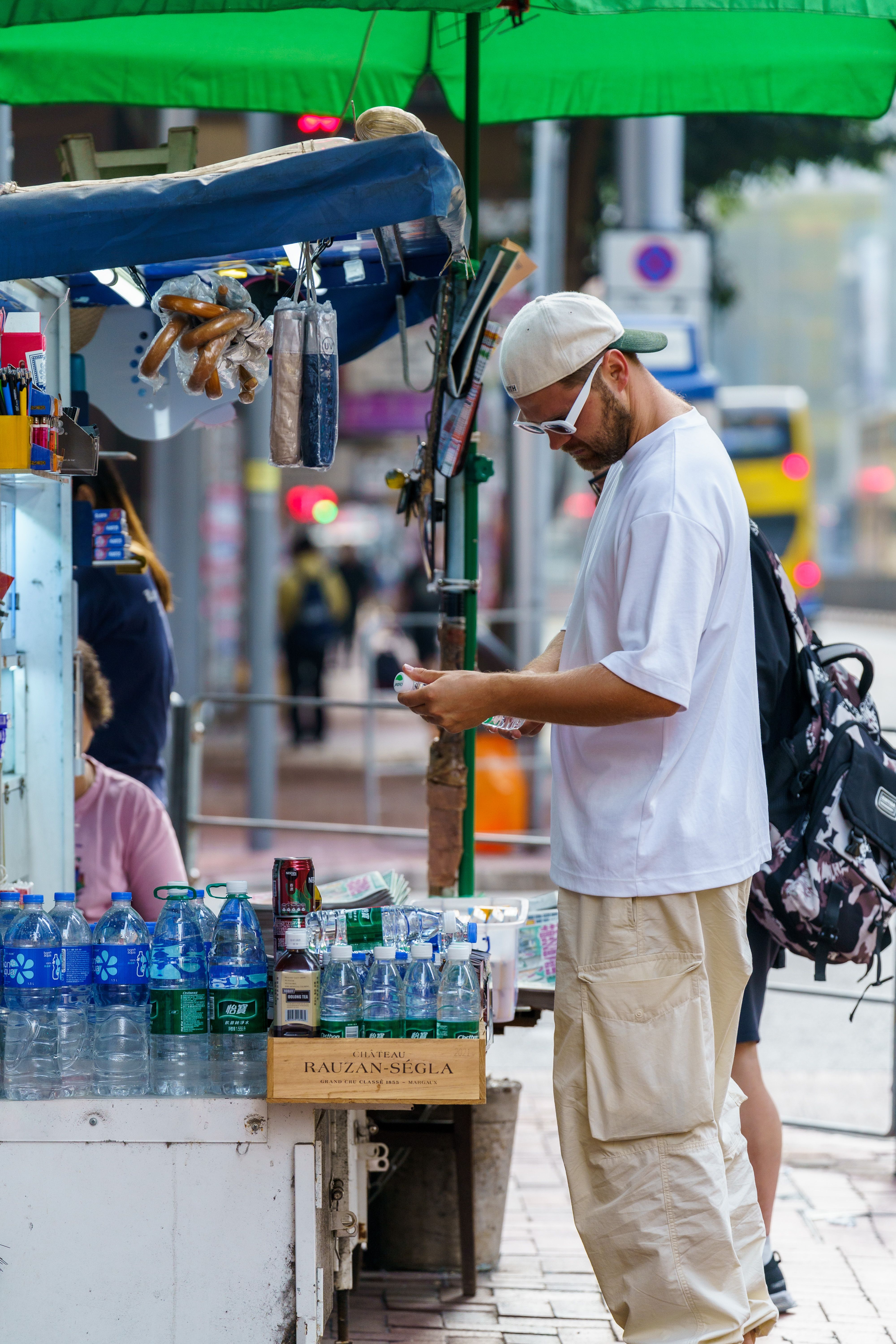 Man Shopping at Street Vendor in Urban Cityscape · Free Stock Photo