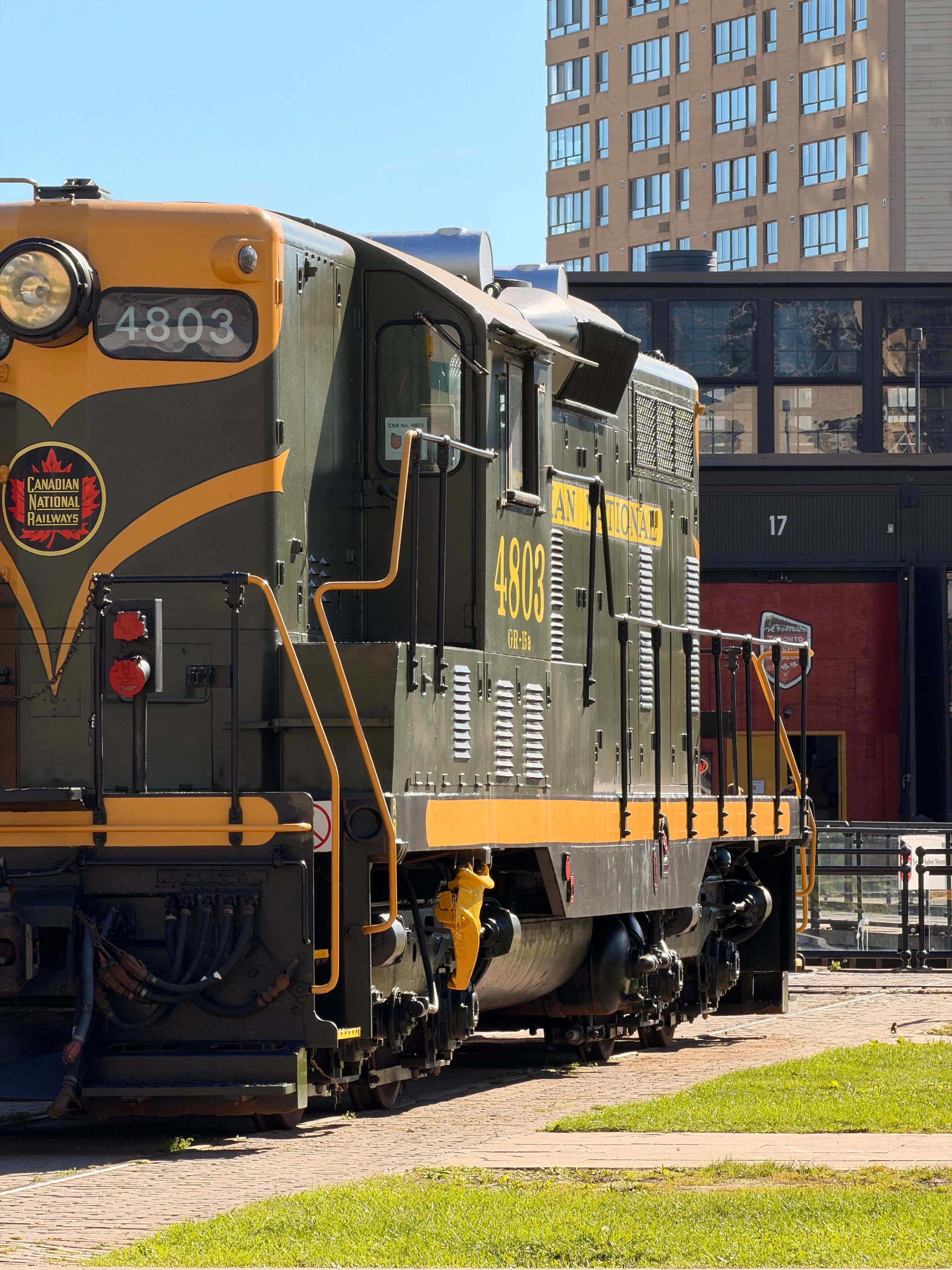 Black and Yellow Train on Rail Road Near Brown Concrete Building · Free ...