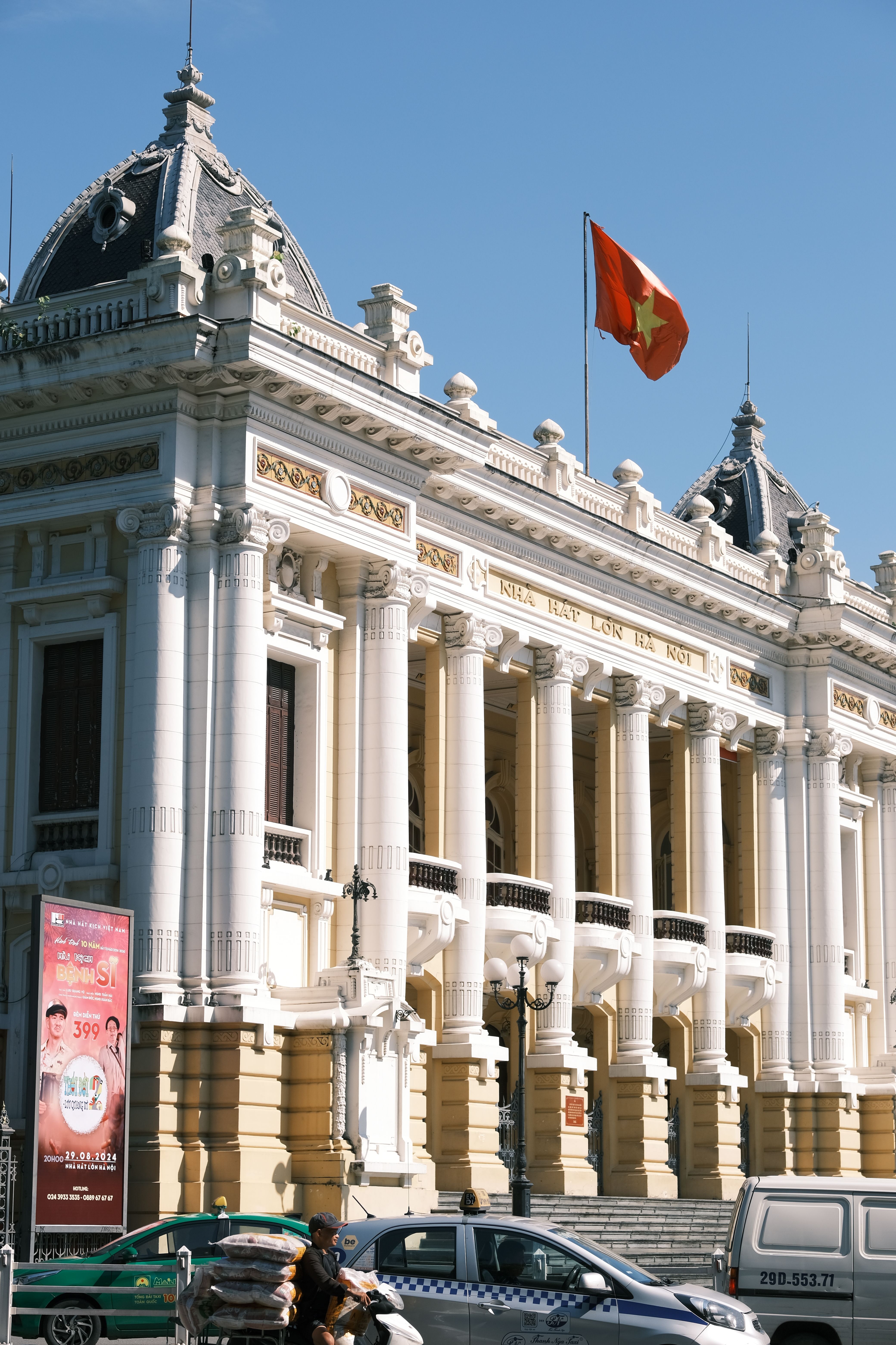 Hanoi Opera House with Vietnamese Flag · Free Stock Photo