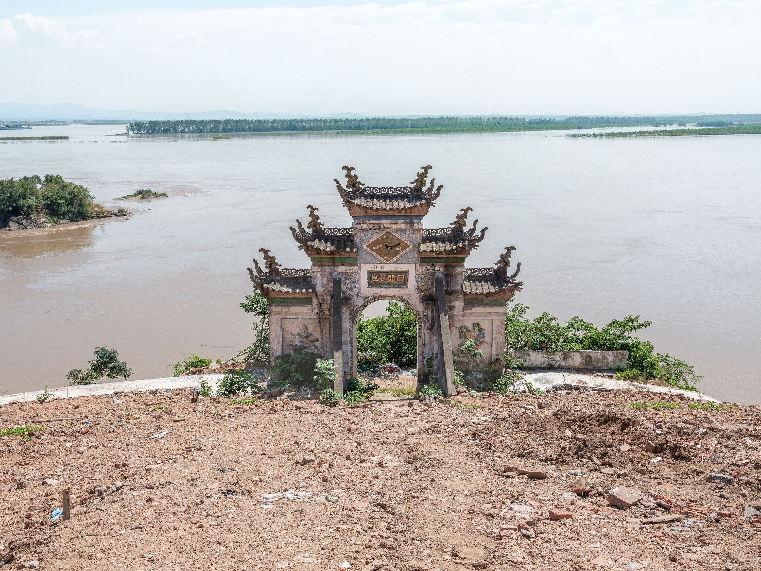 Serene View of Traditional Asian Gateway by River · Free Stock Photo