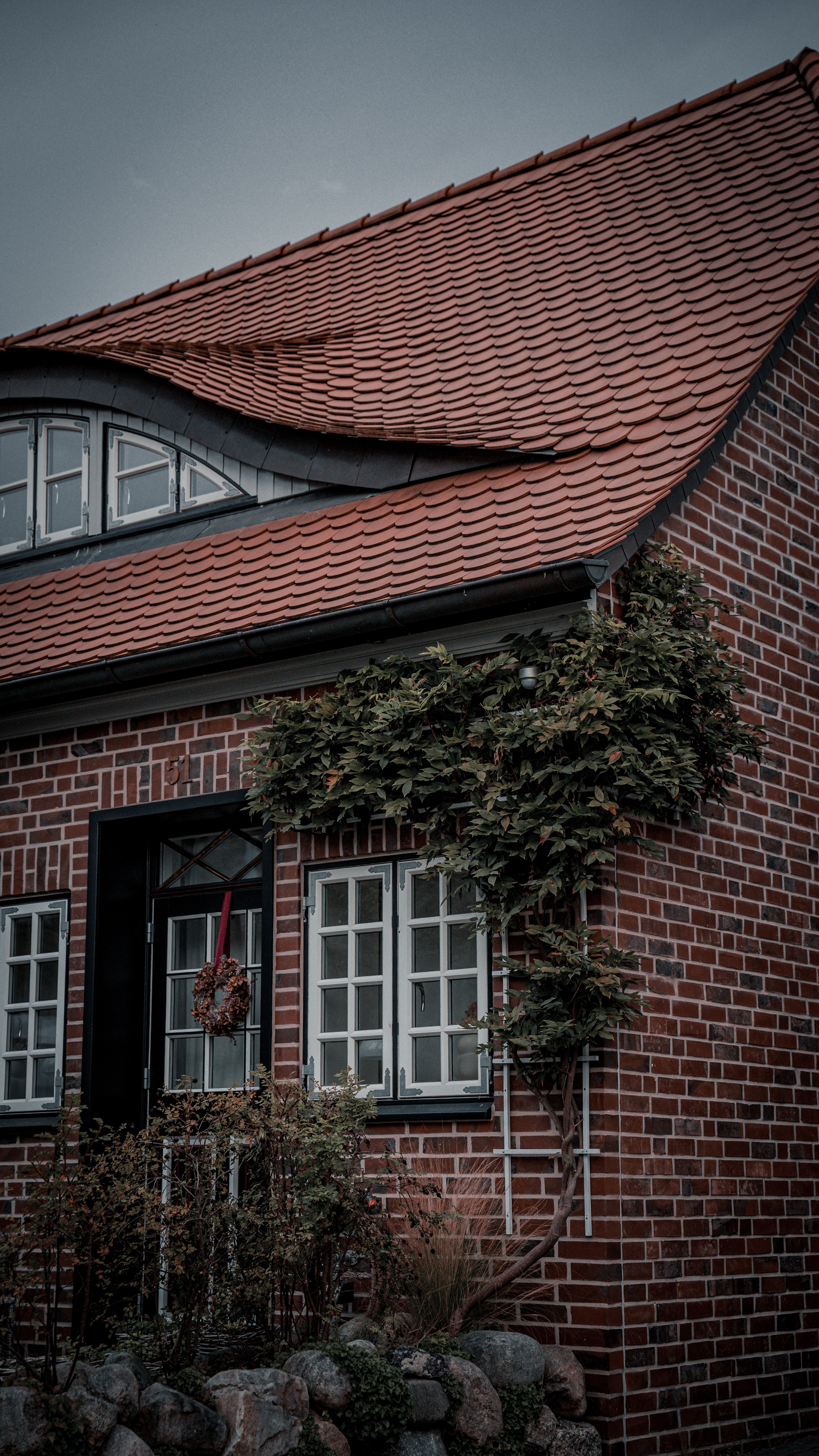 Charming Brick House with Red Roof and Plants · Free Stock Photo
