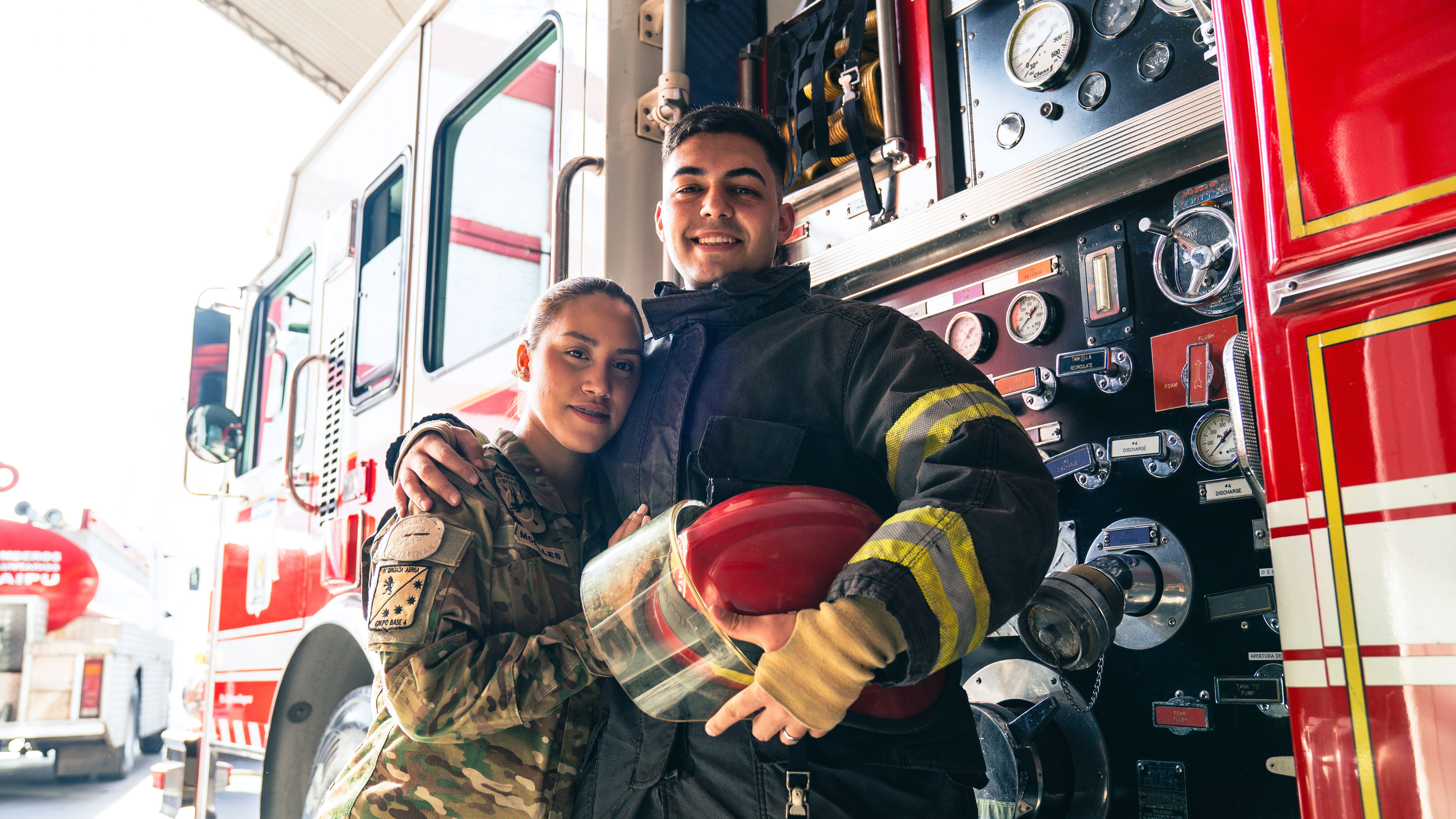 Firefighter and Soldier Standing by Fire Truck · Free Stock Photo