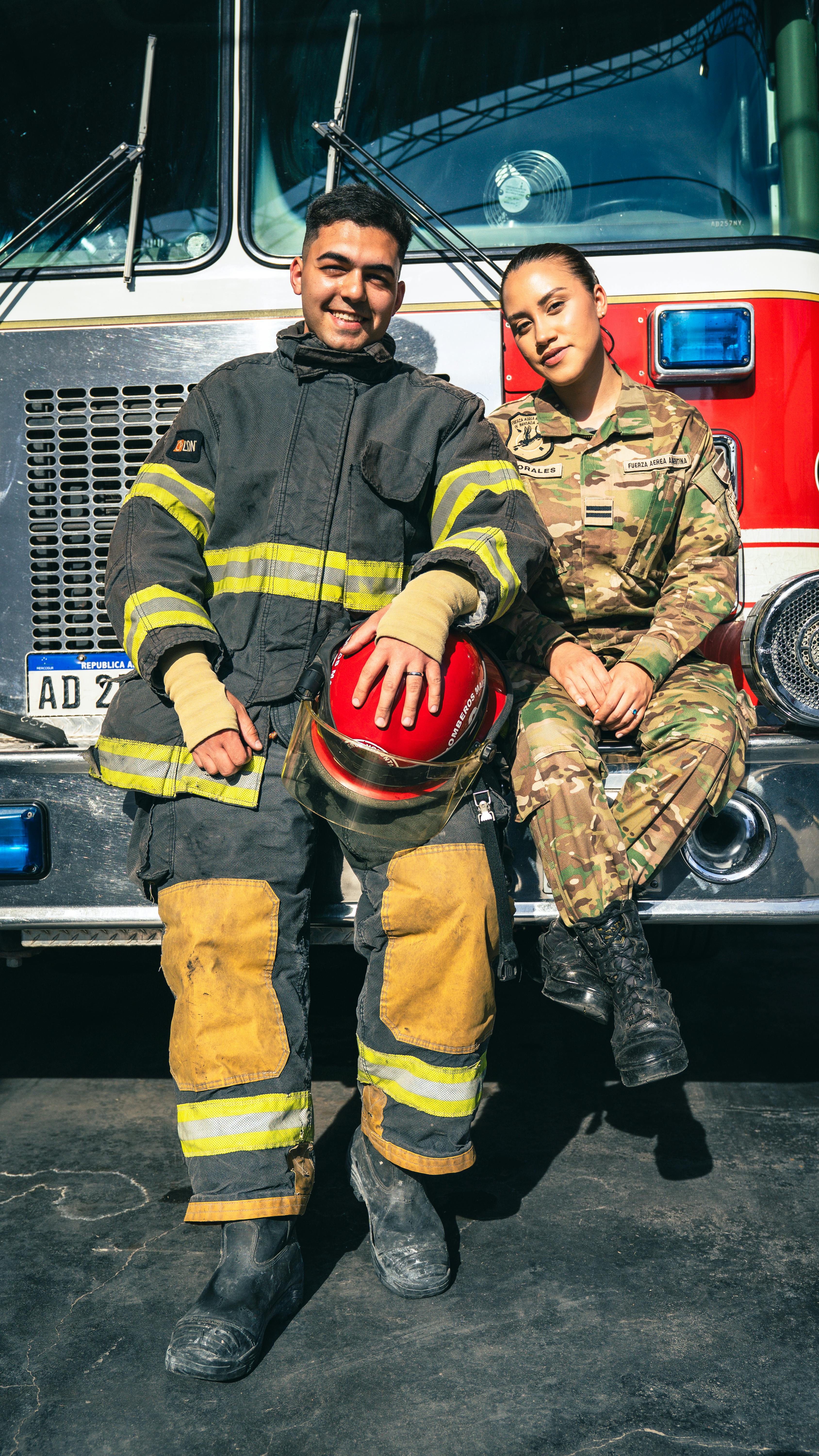 Firefighter and Soldier Posing by Fire Truck · Free Stock Photo
