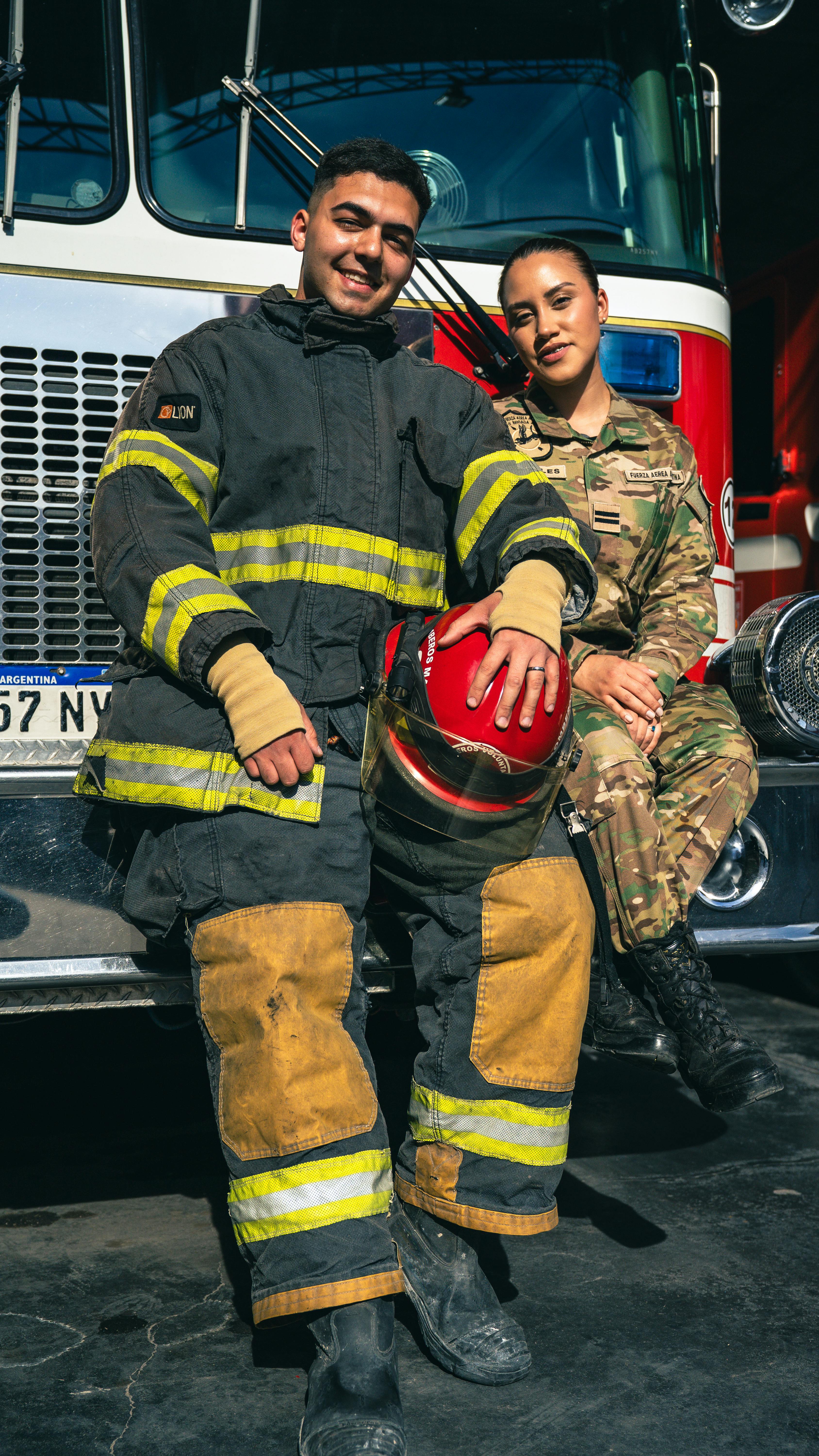 Firefighter and Soldier Posing by Fire Truck · Free Stock Photo