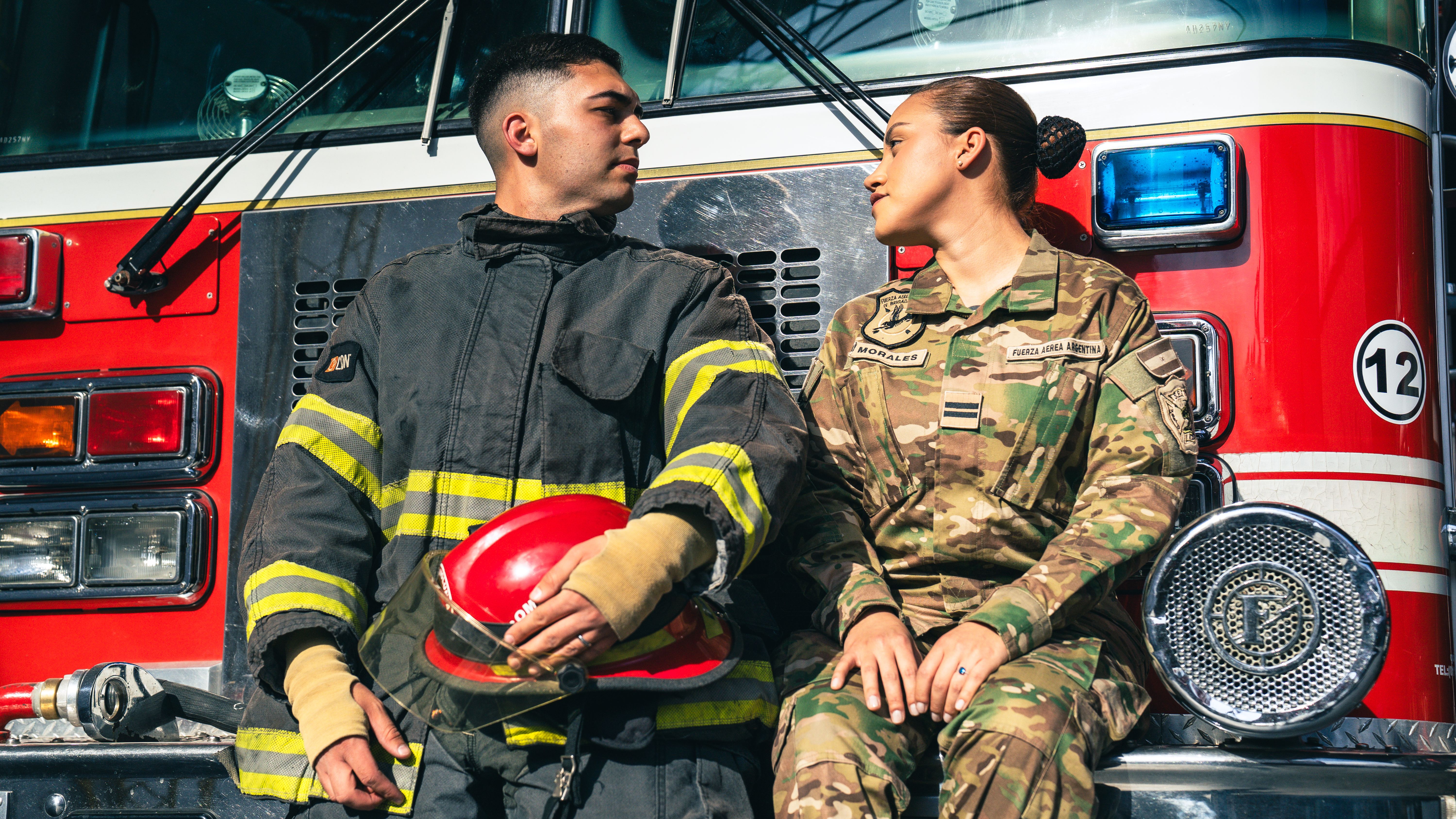 Firefighter and Soldier Sharing a Moment · Free Stock Photo