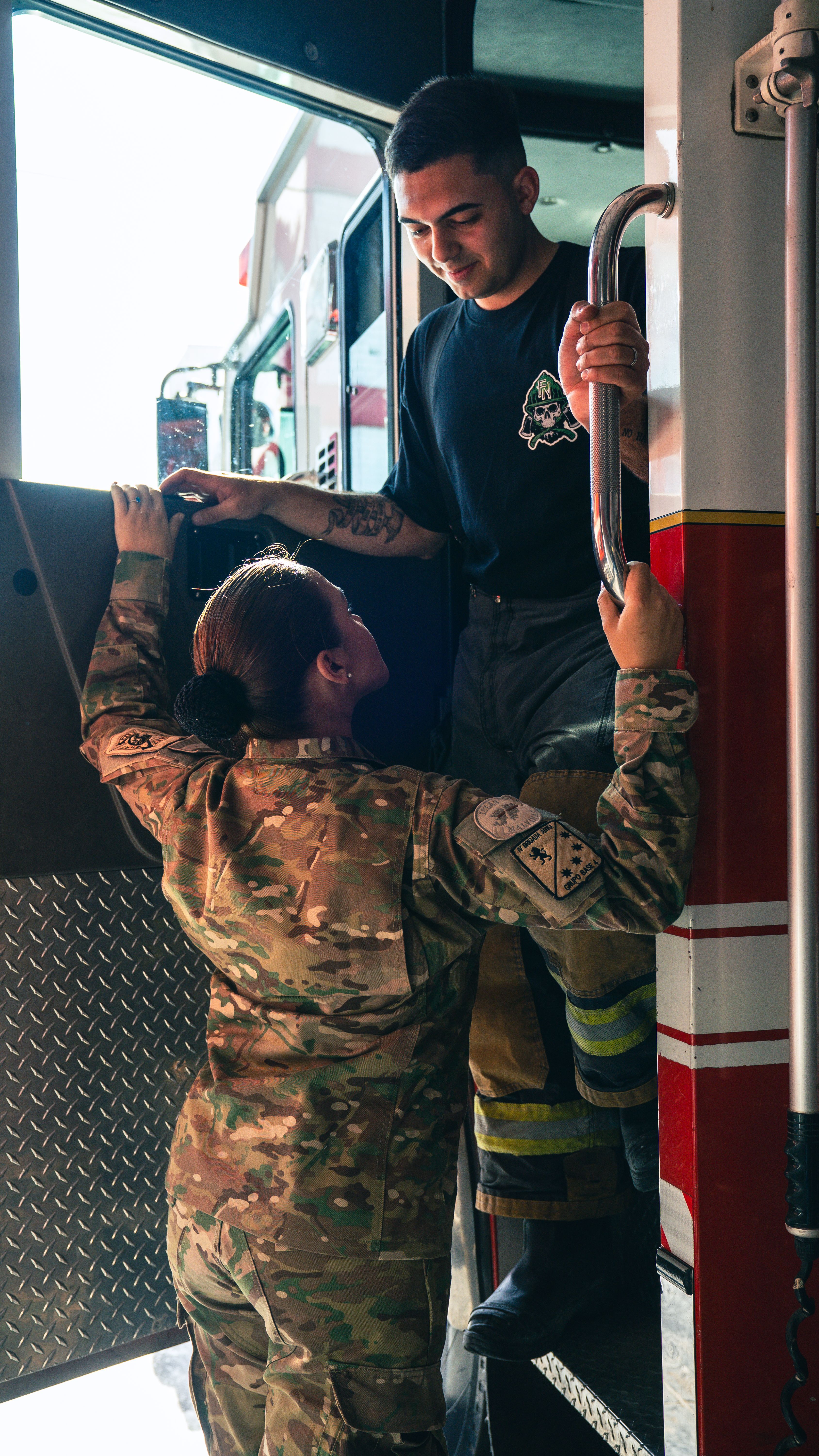 Firefighter and Soldier in a Moment of Support · Free Stock Photo