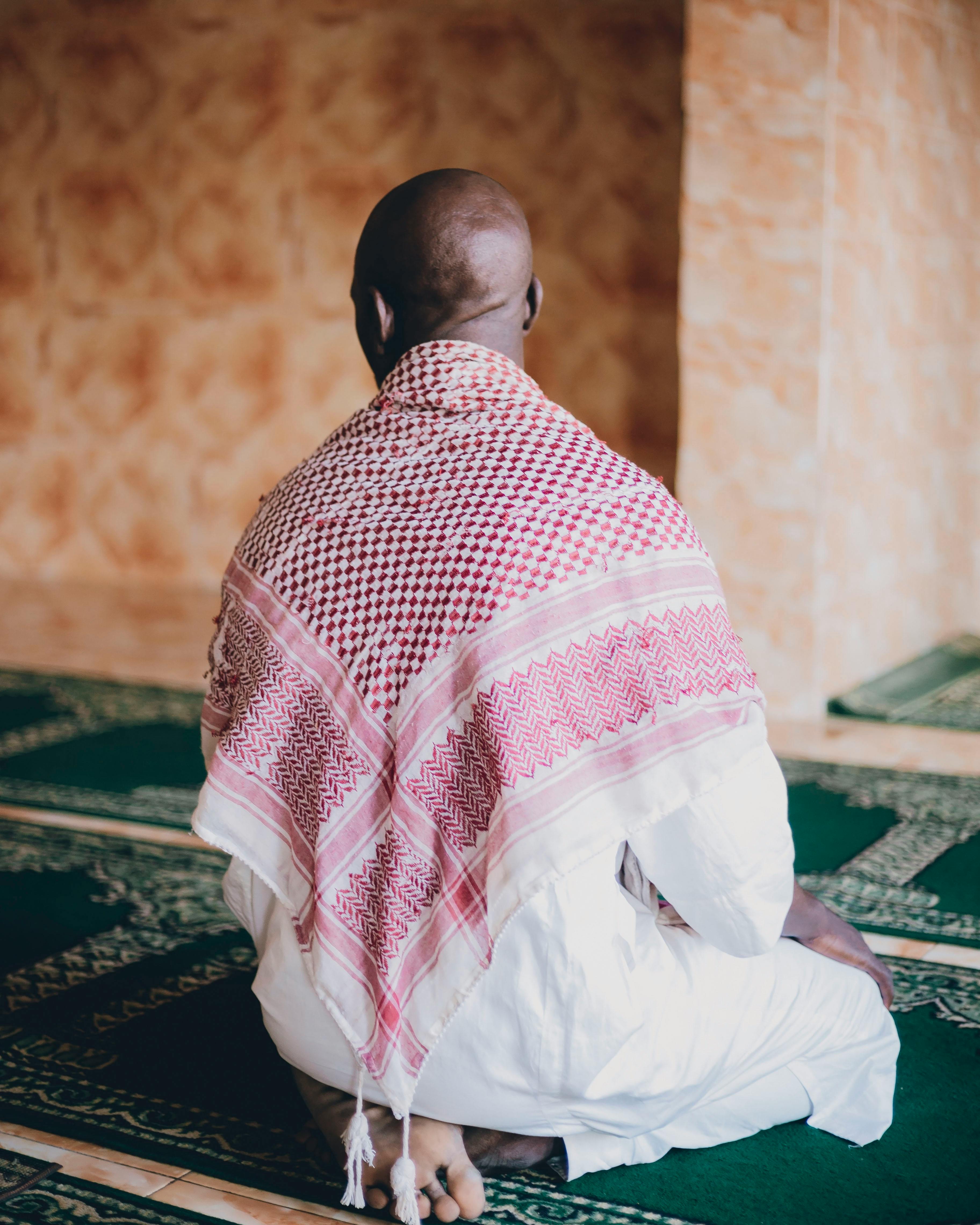 African Man Praying in a Mosque Setting · Free Stock Photo