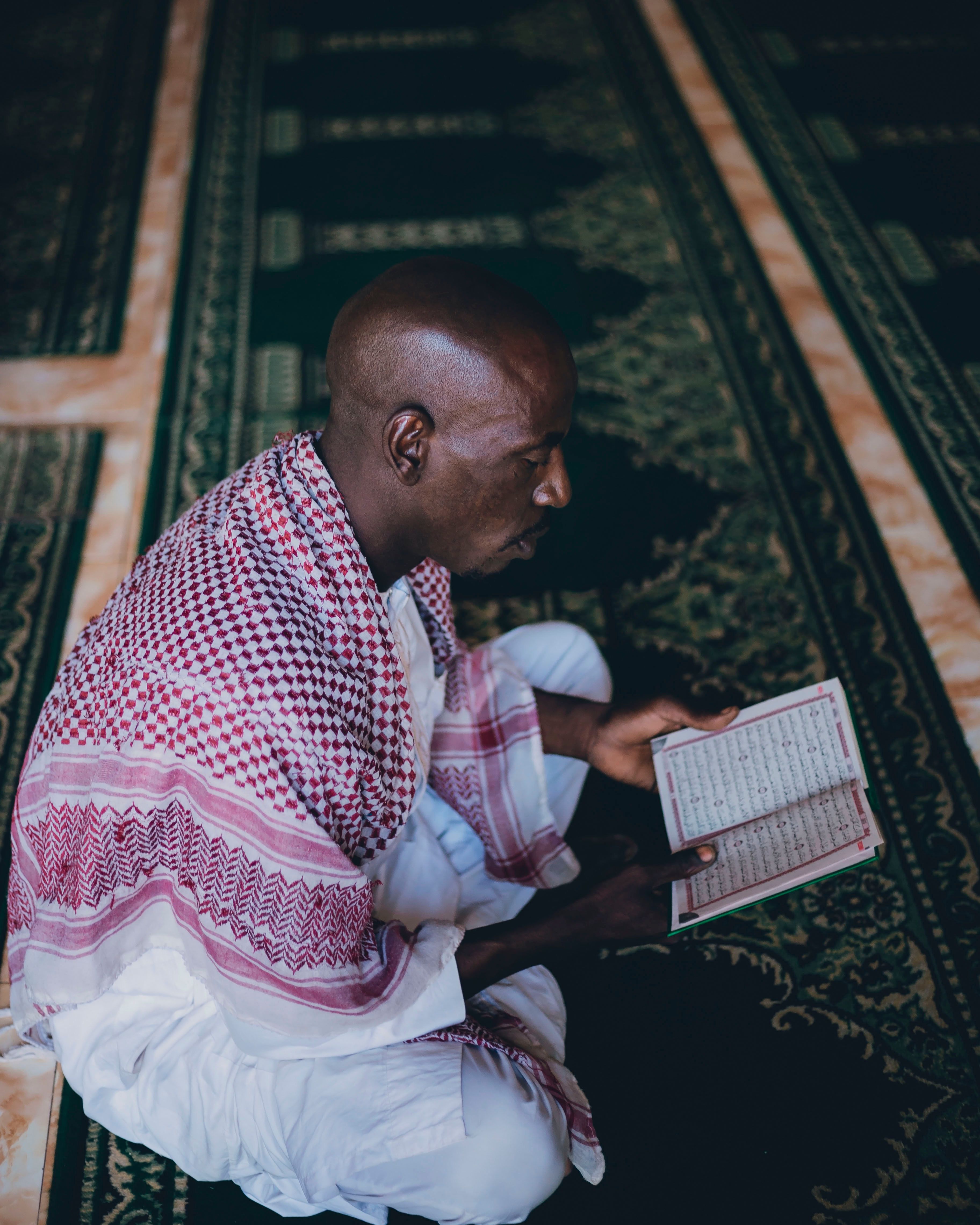 Man Praying Indoors in a Mosque Setting · Free Stock Photo