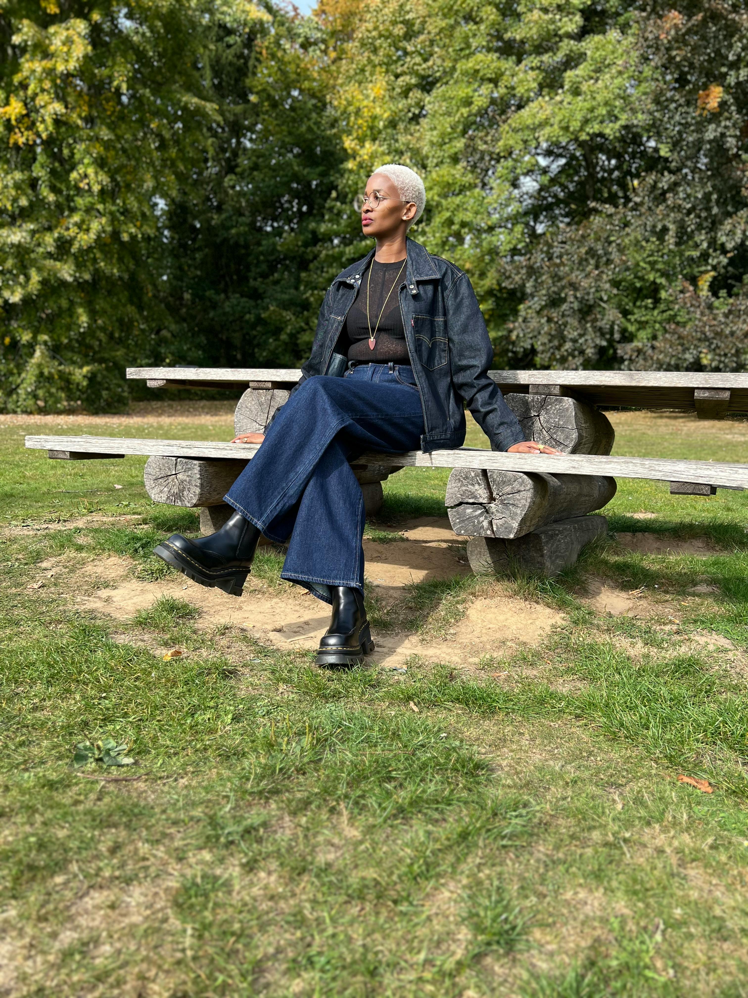 Woman Relaxing on Outdoor Wooden Bench in Park · Free Stock Photo