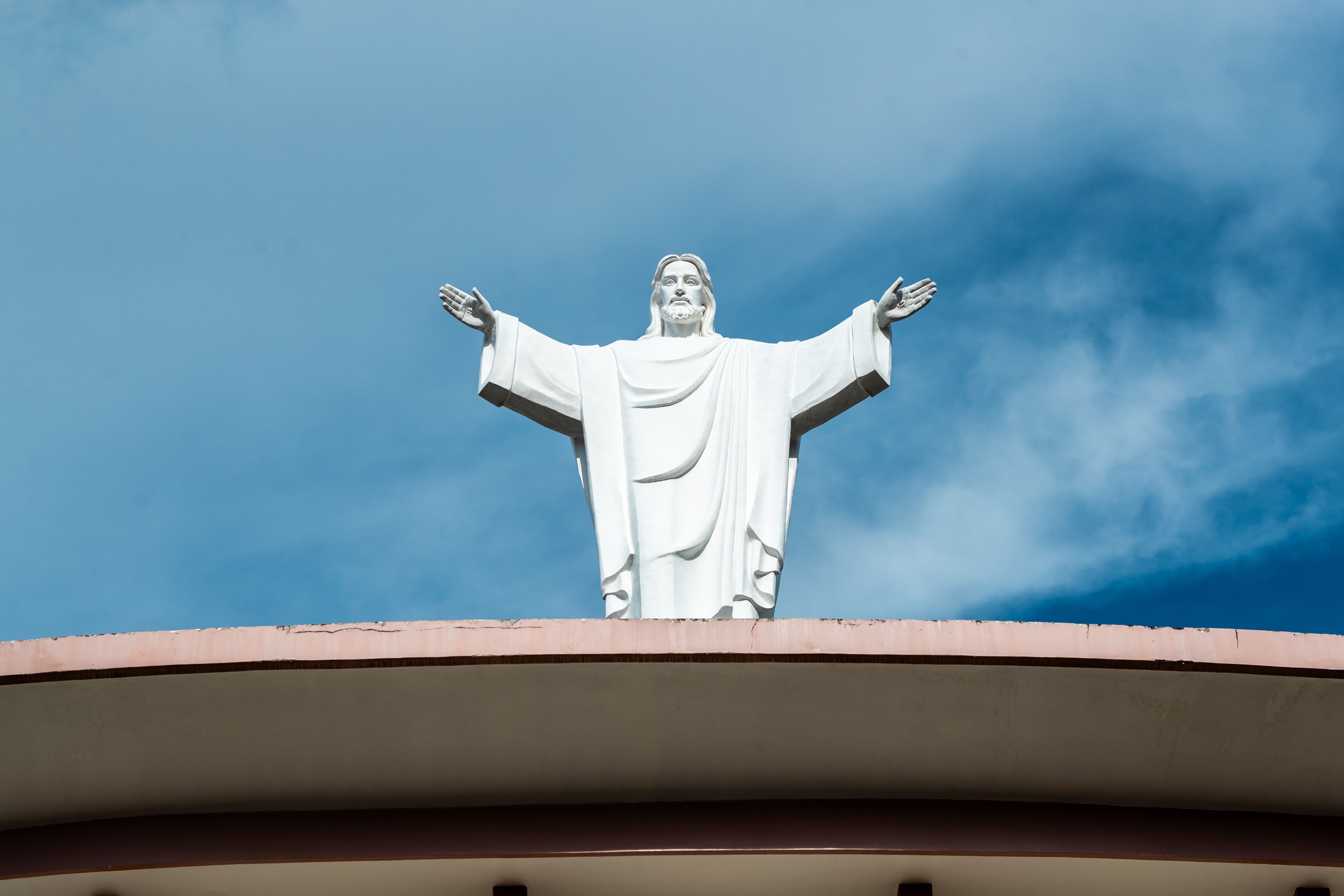 Statue of Jesus Christ Against Blue Sky · Free Stock Photo