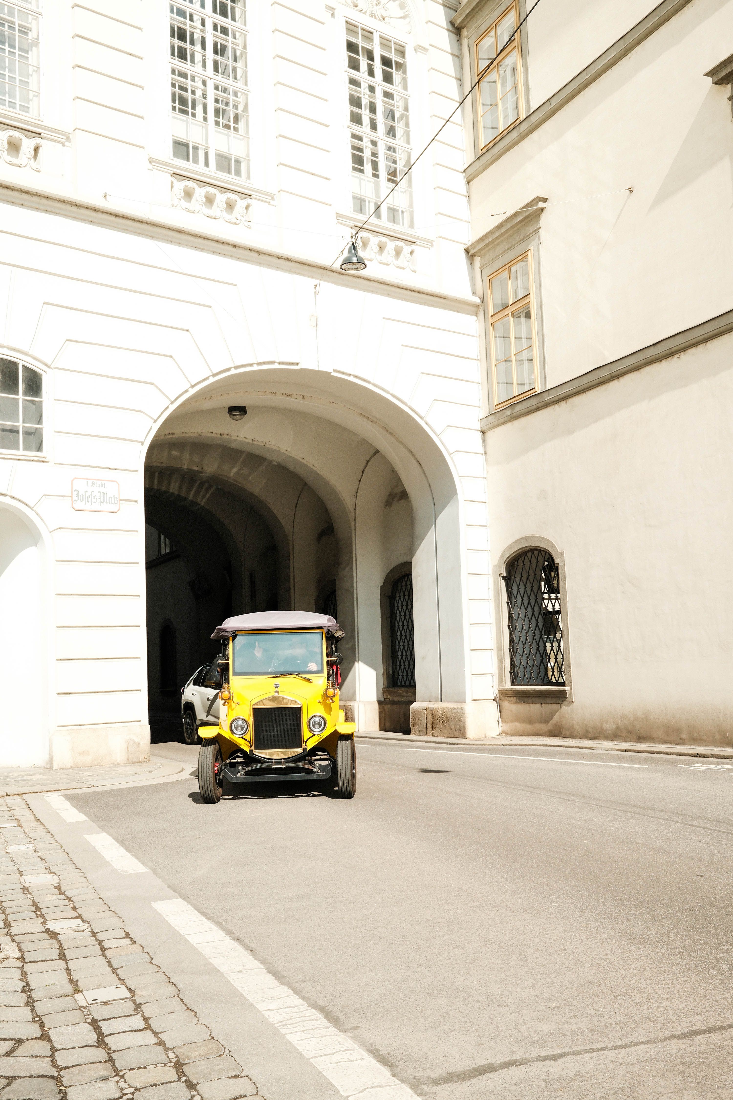 Vintage Car in Vienna's Historic Archway · Free Stock Photo