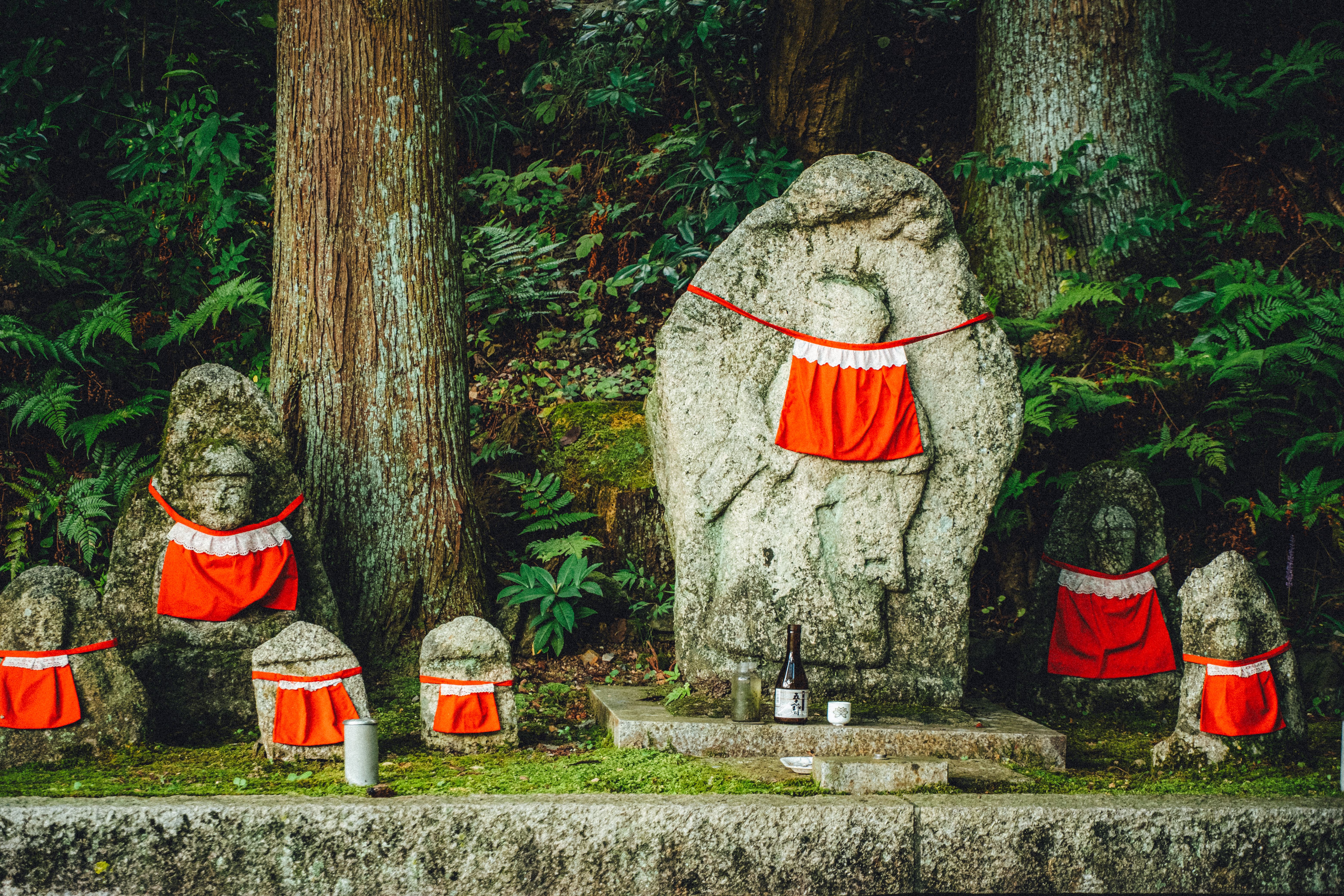 Sacred Stone Statues in Forest Setting · Free Stock Photo