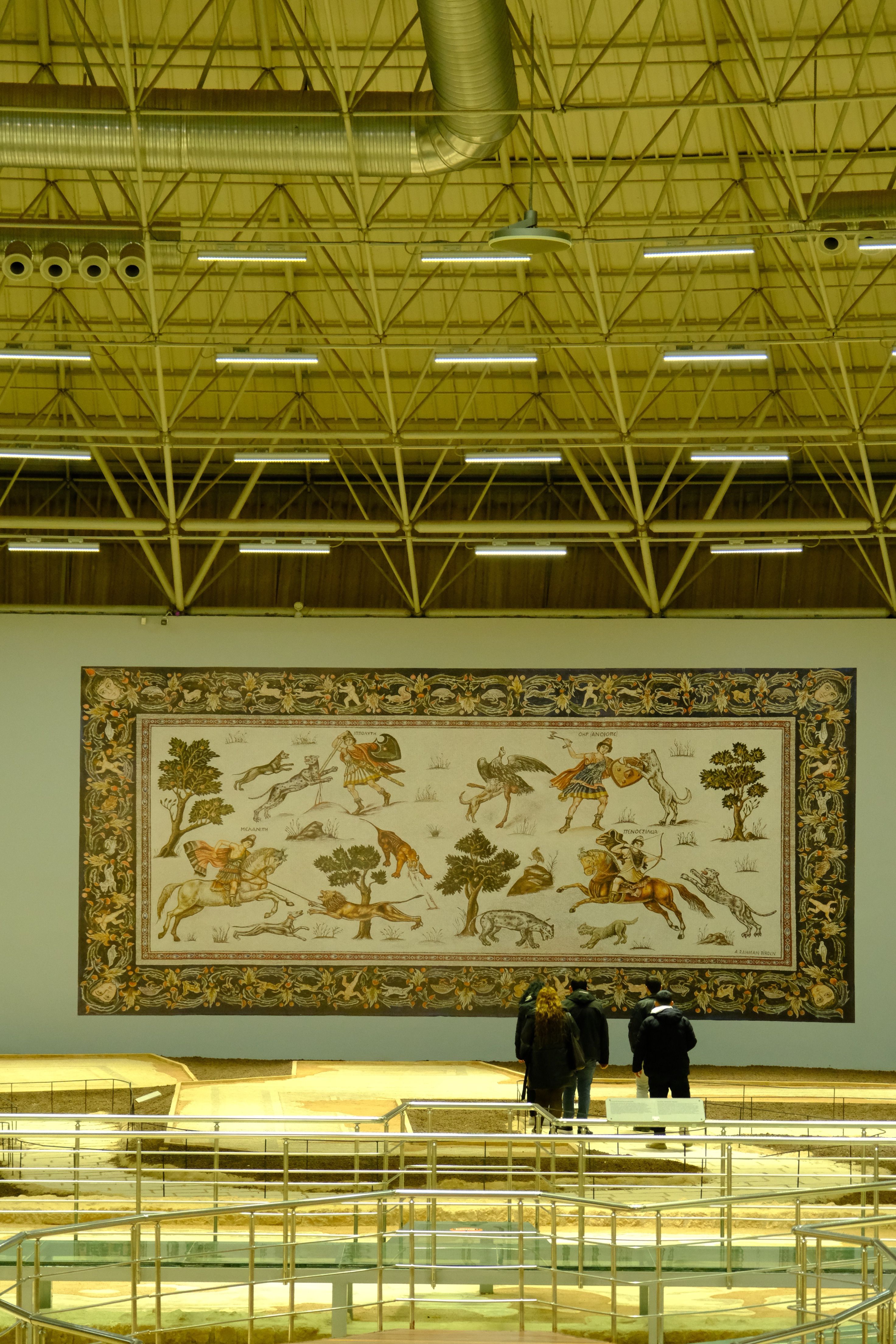 Museum interior showcasing large traditional tapestry · Free Stock Photo