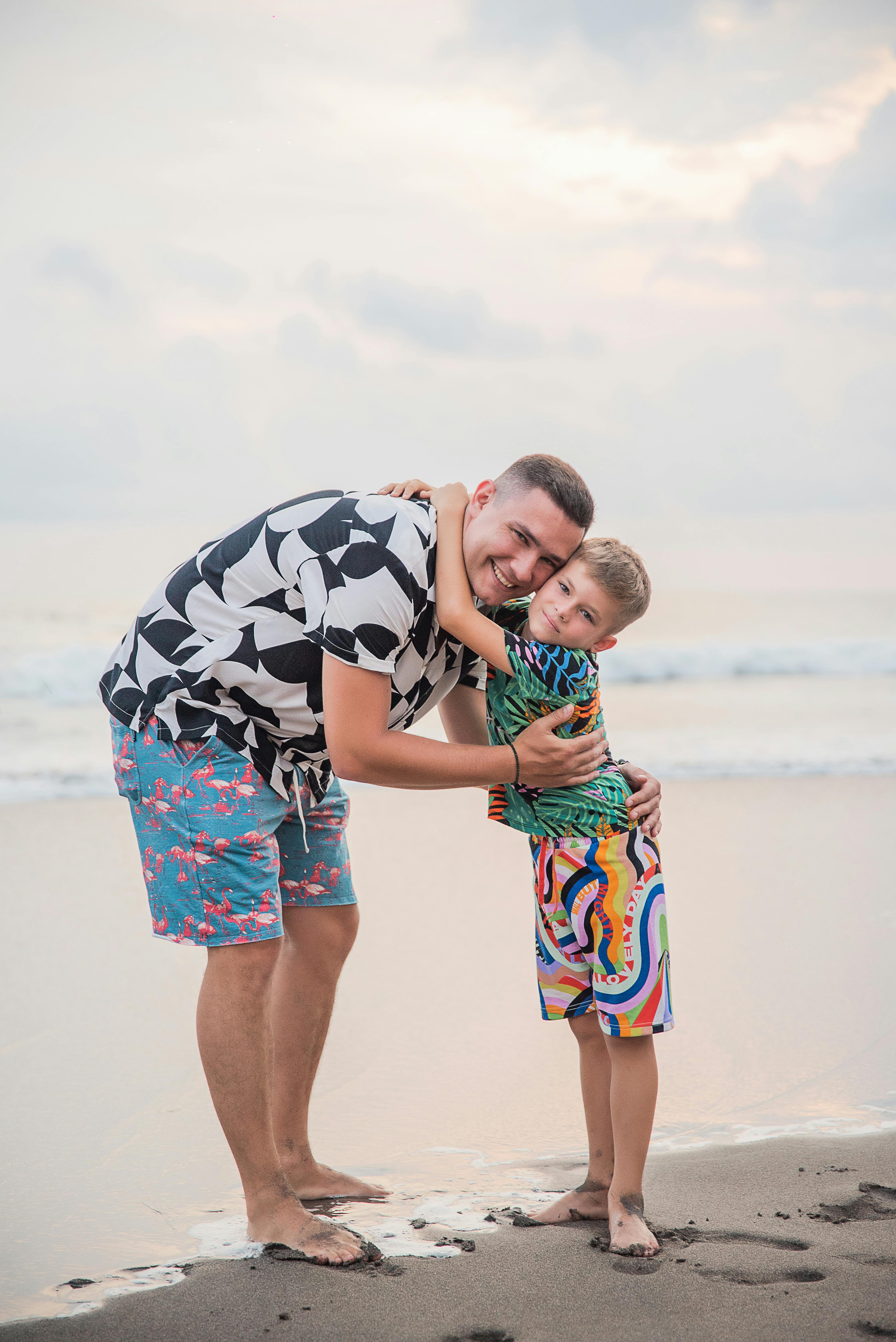 Father and son bonding at the beach during sunset · Free Stock Photo