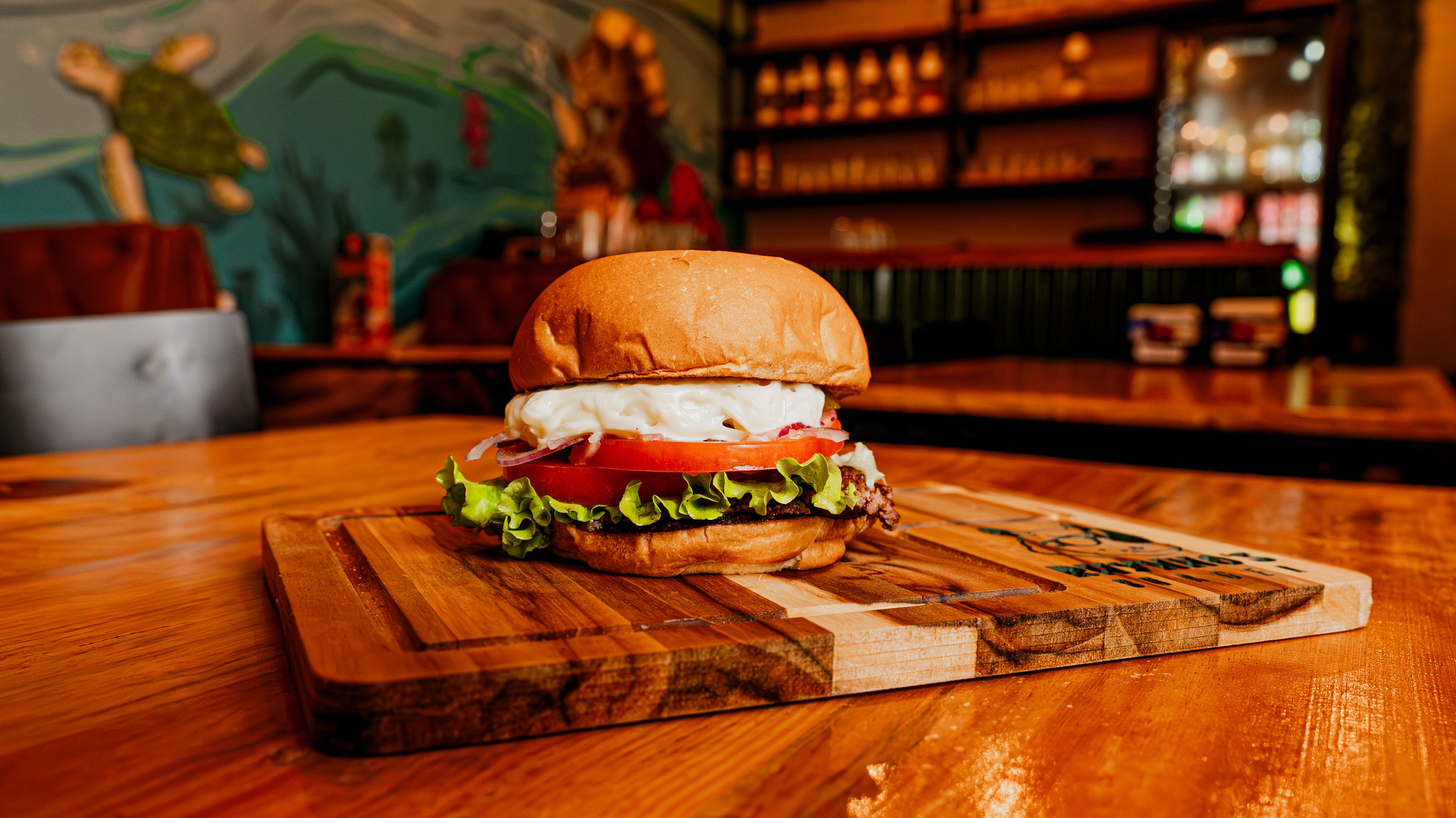Delicious Cheeseburger on Wooden Board in Cafe · Free Stock Photo