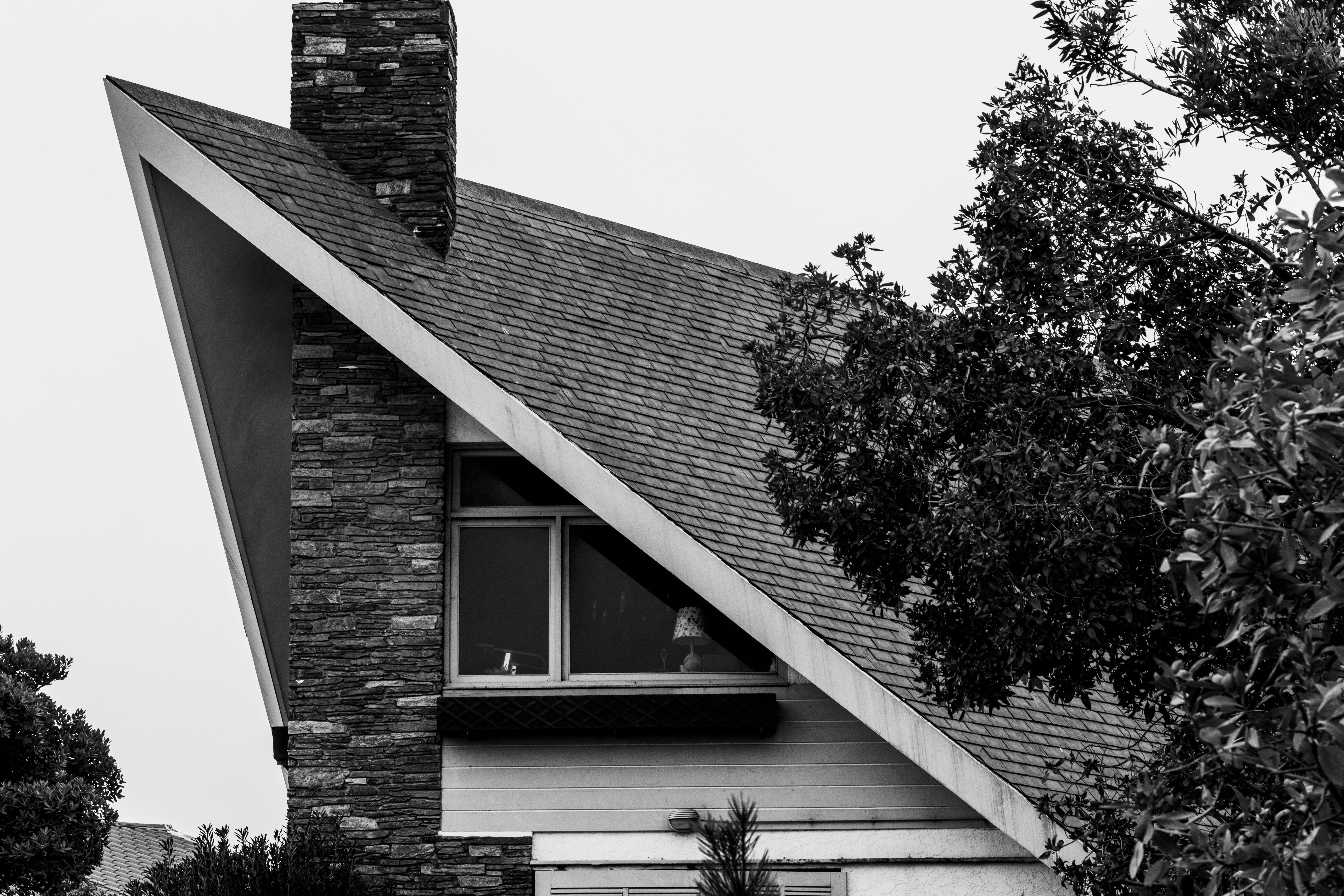 Modern A-frame house with geometric roof design · Free Stock Photo