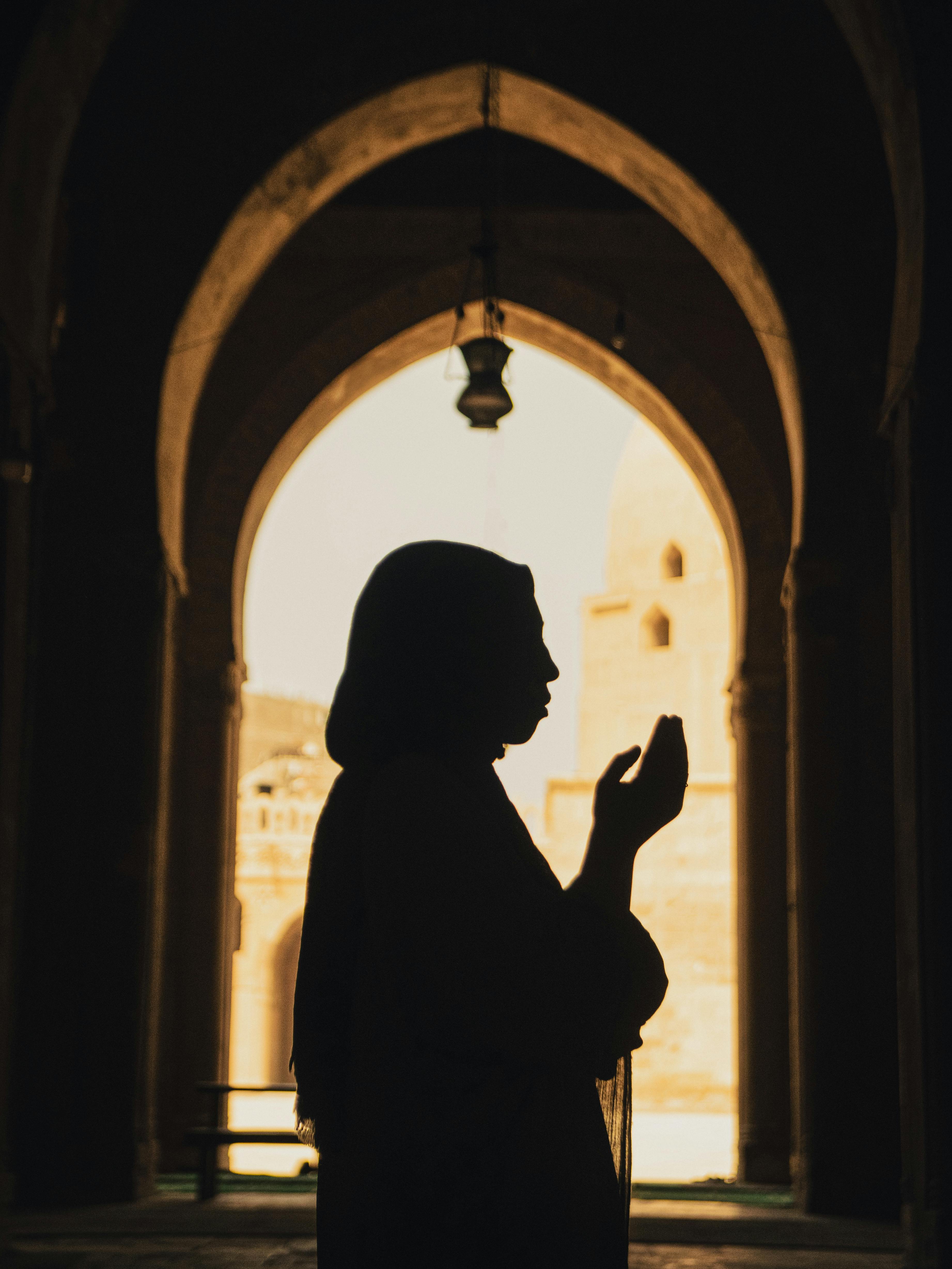 Silhouette of Woman Praying Inside Egyptian Mosque · Free Stock Photo