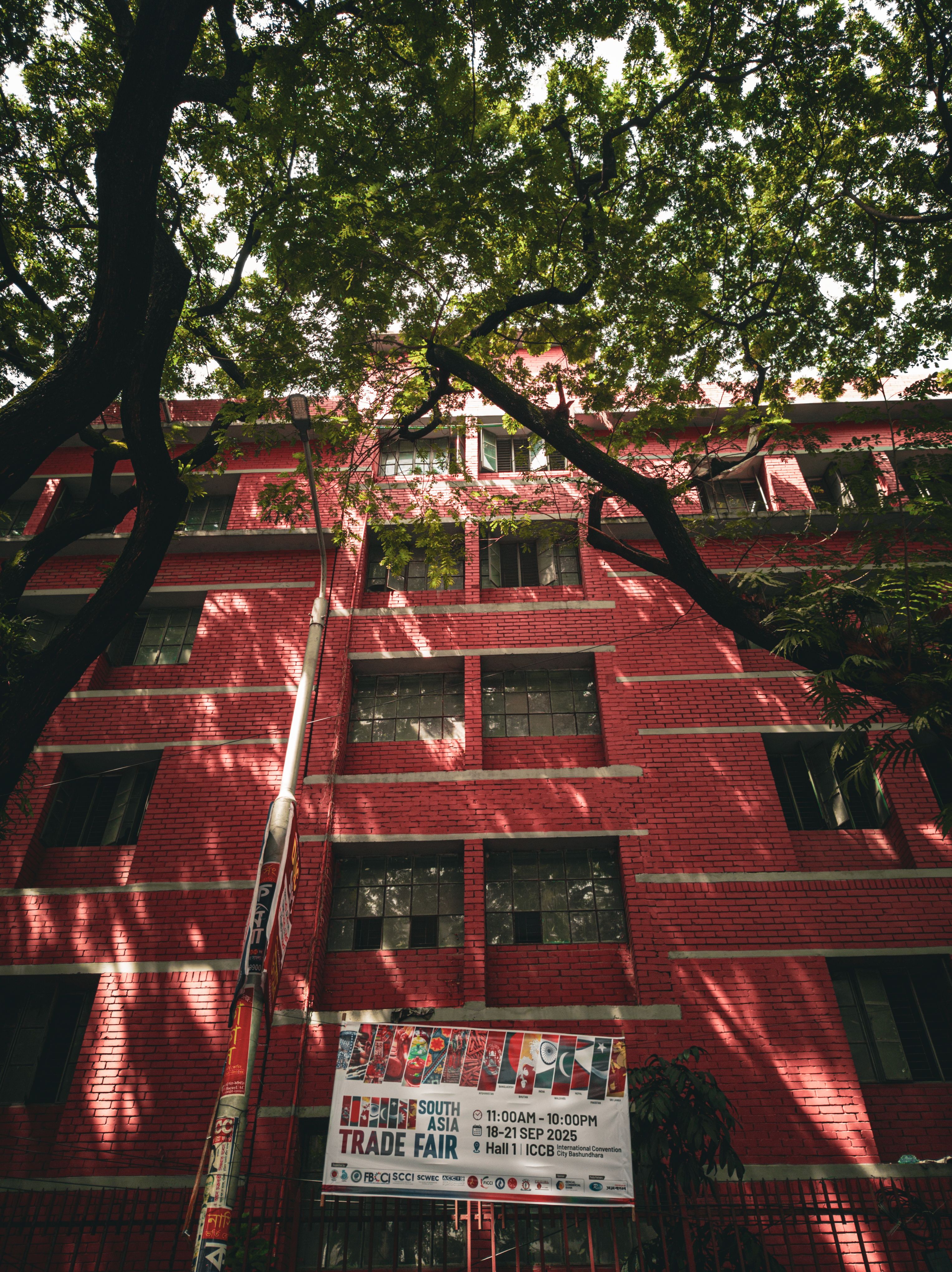 Red Brick Building in Dhaka with Trade Fair Sign · Free Stock Photo