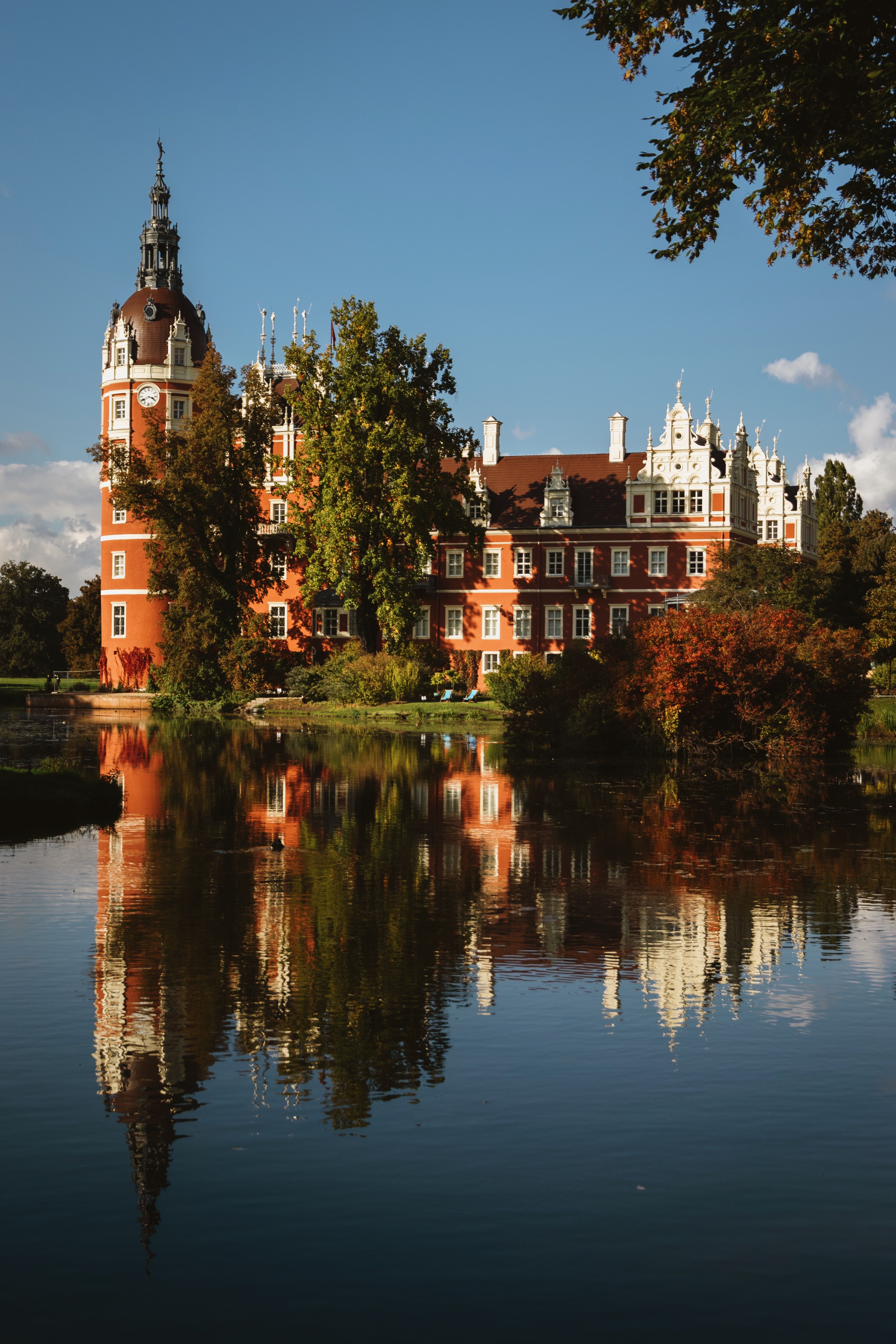 Majestic Muskau Castle Reflected in Autumn Lake · Free Stock Photo