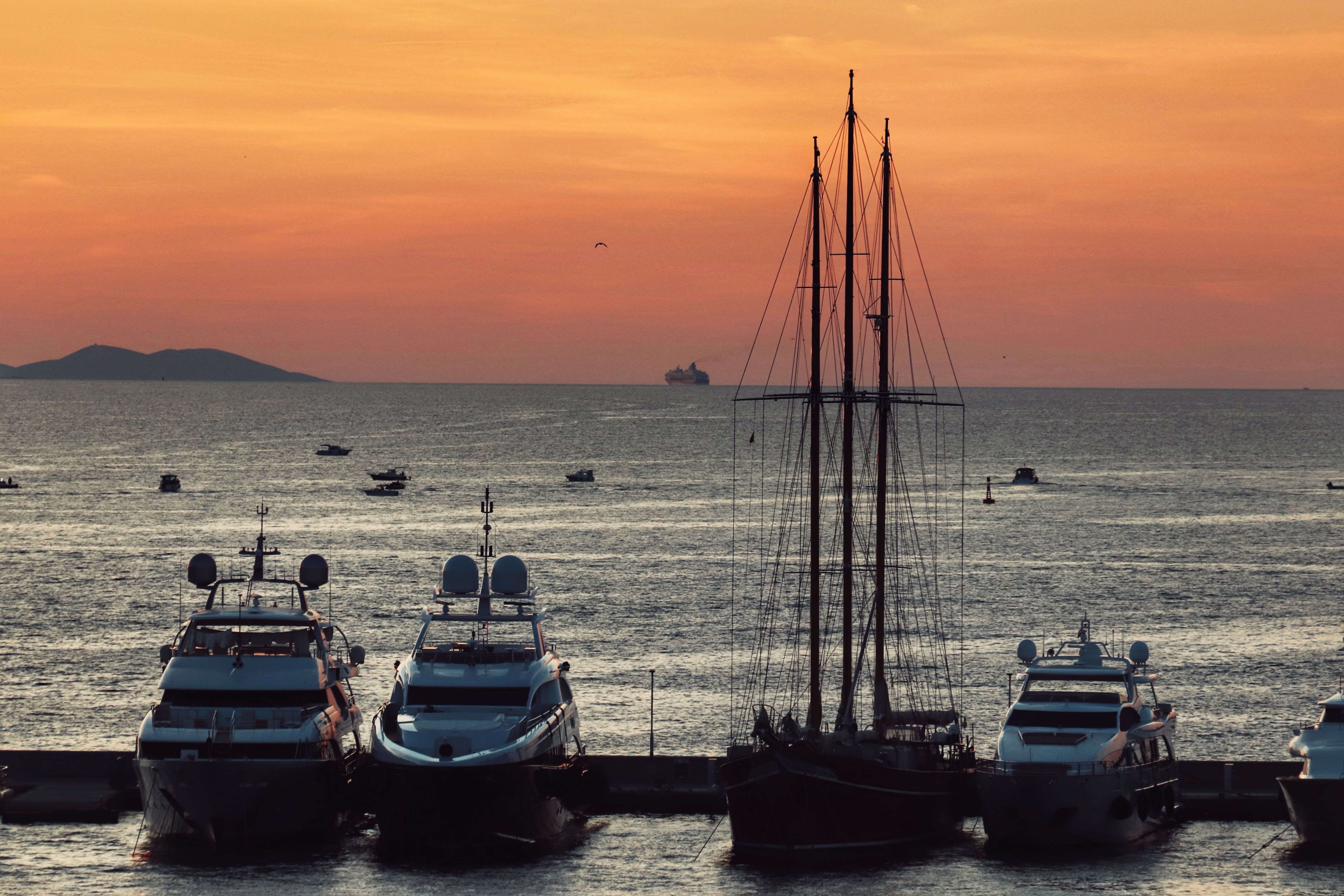 Sunset Seaside with Yachts and Sailboat at Dock · Free Stock Photo