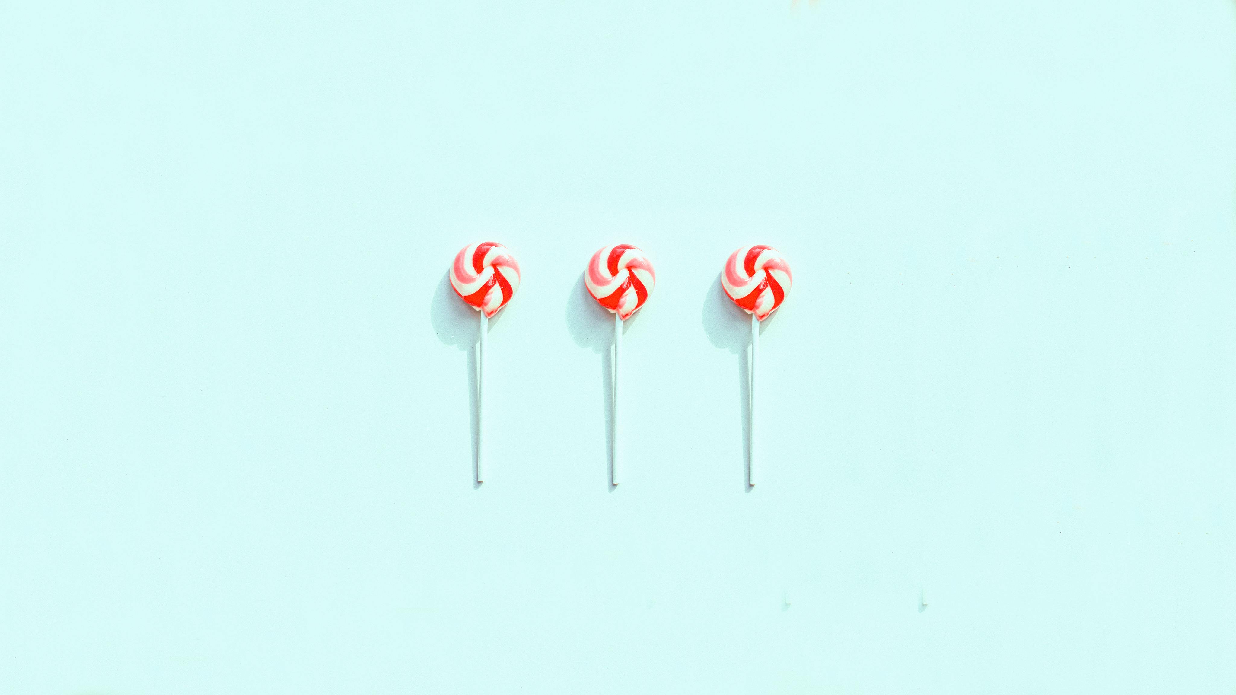 Lollipops on Blue Surface · Free Stock Photo