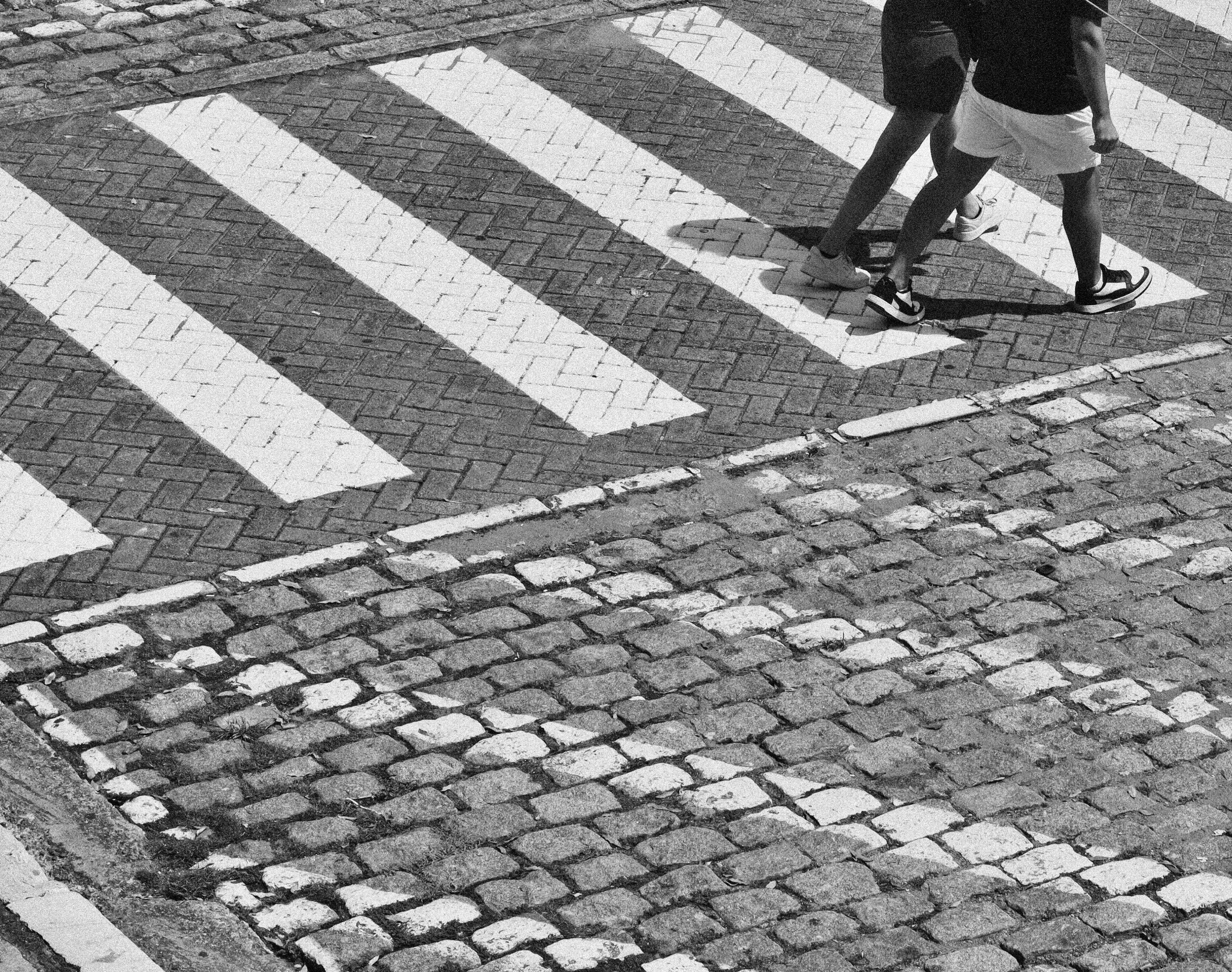 Monochrome Urban Crosswalk Scene with Pedestrians · Free Stock Photo