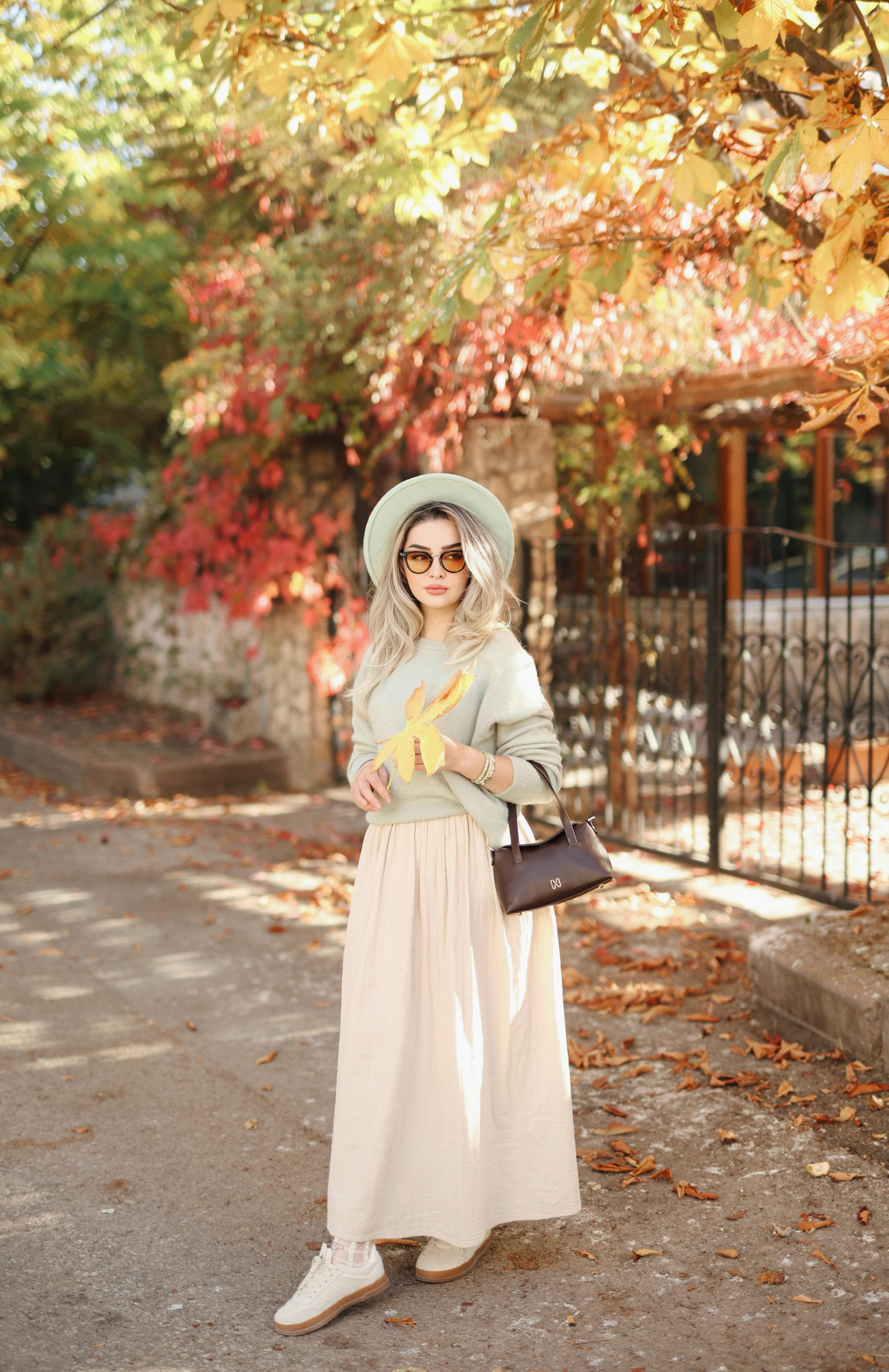 Chic Autumn Fashion in Sunlit Street Setting · Free Stock Photo