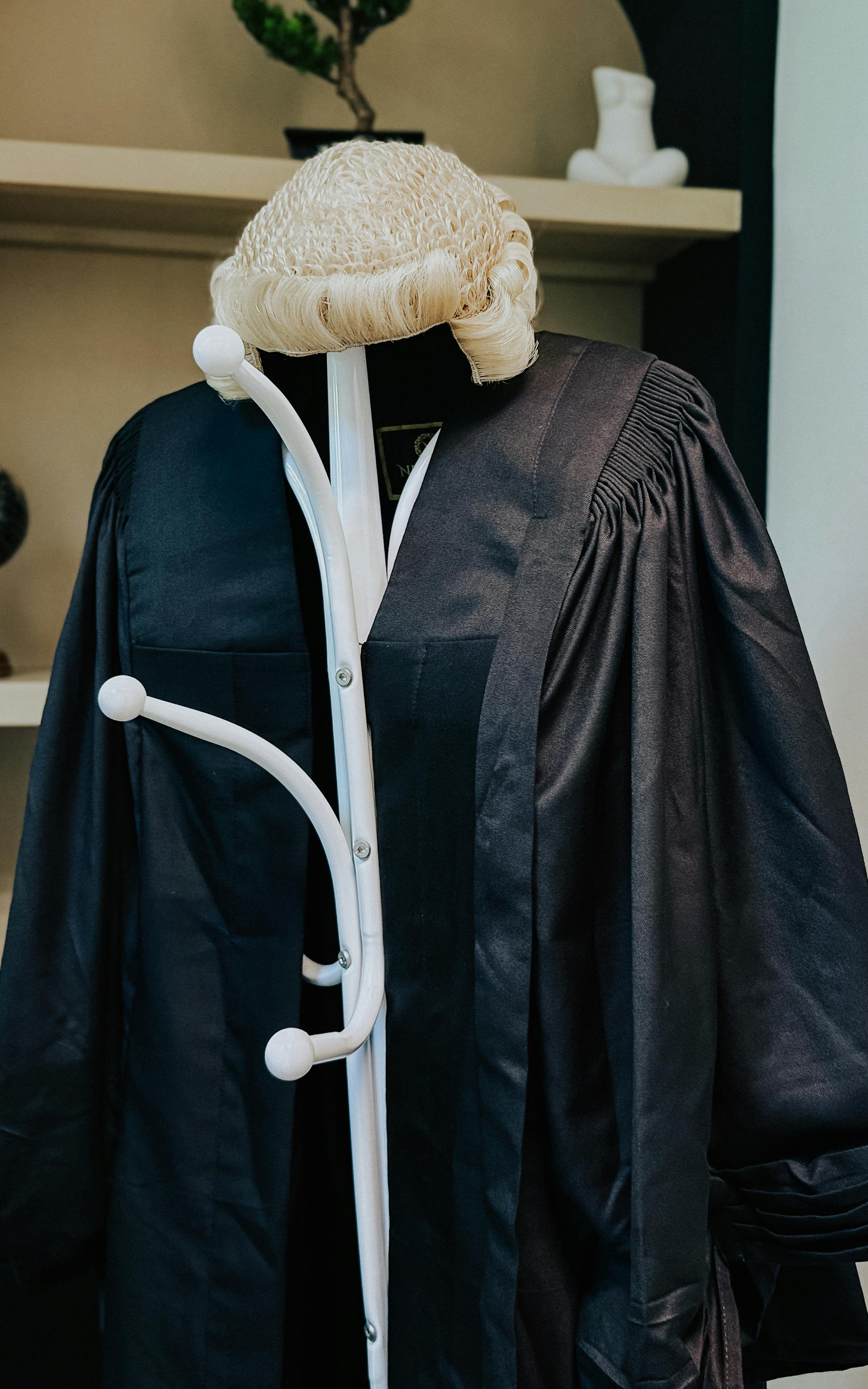 Close-up of Barrister Robe and Wig on Stand · Free Stock Photo