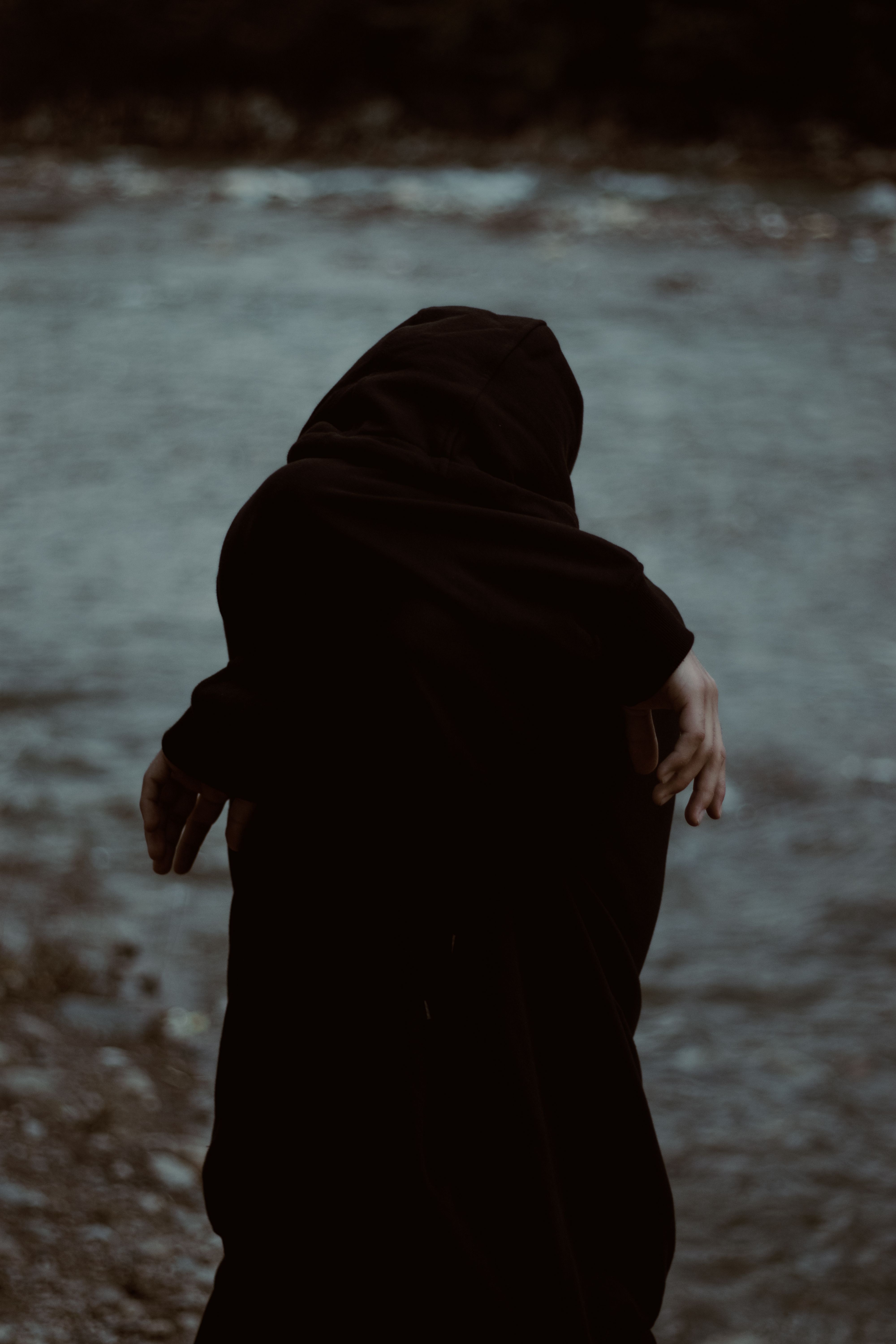 Mysterious Figure in Black Cloak by River · Free Stock Photo