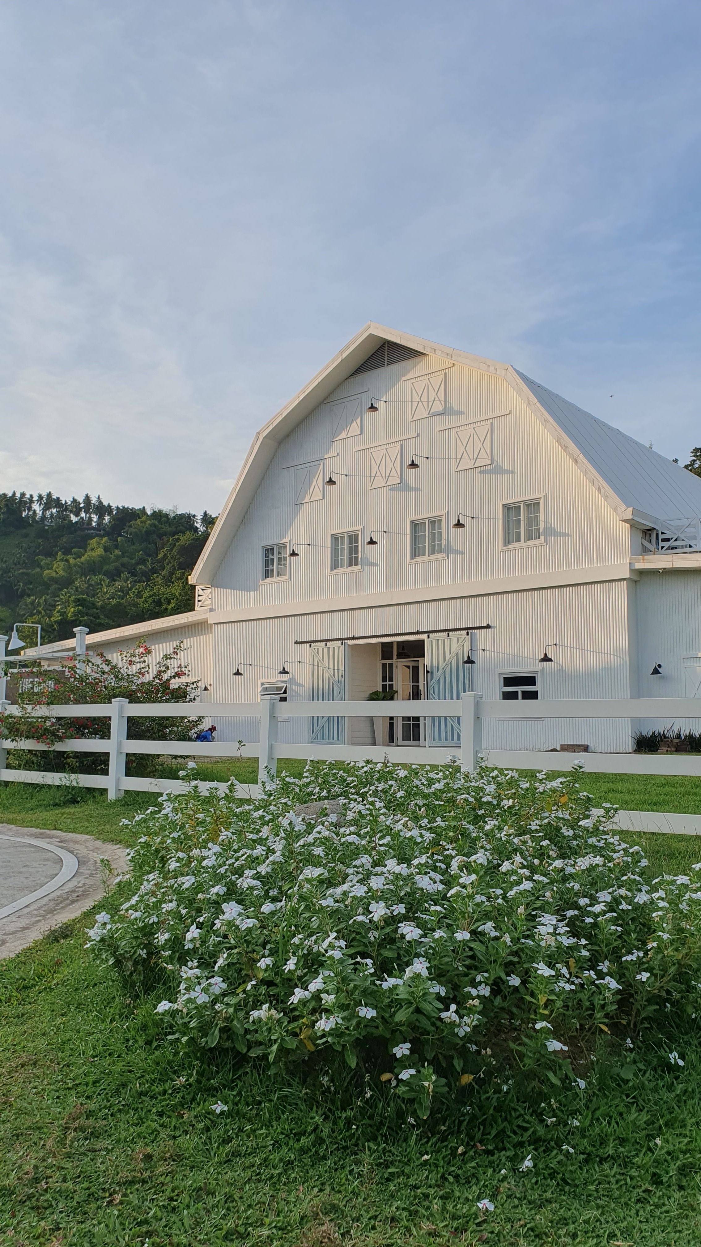 Charming White Barn with Flower Garden · Free Stock Photo
