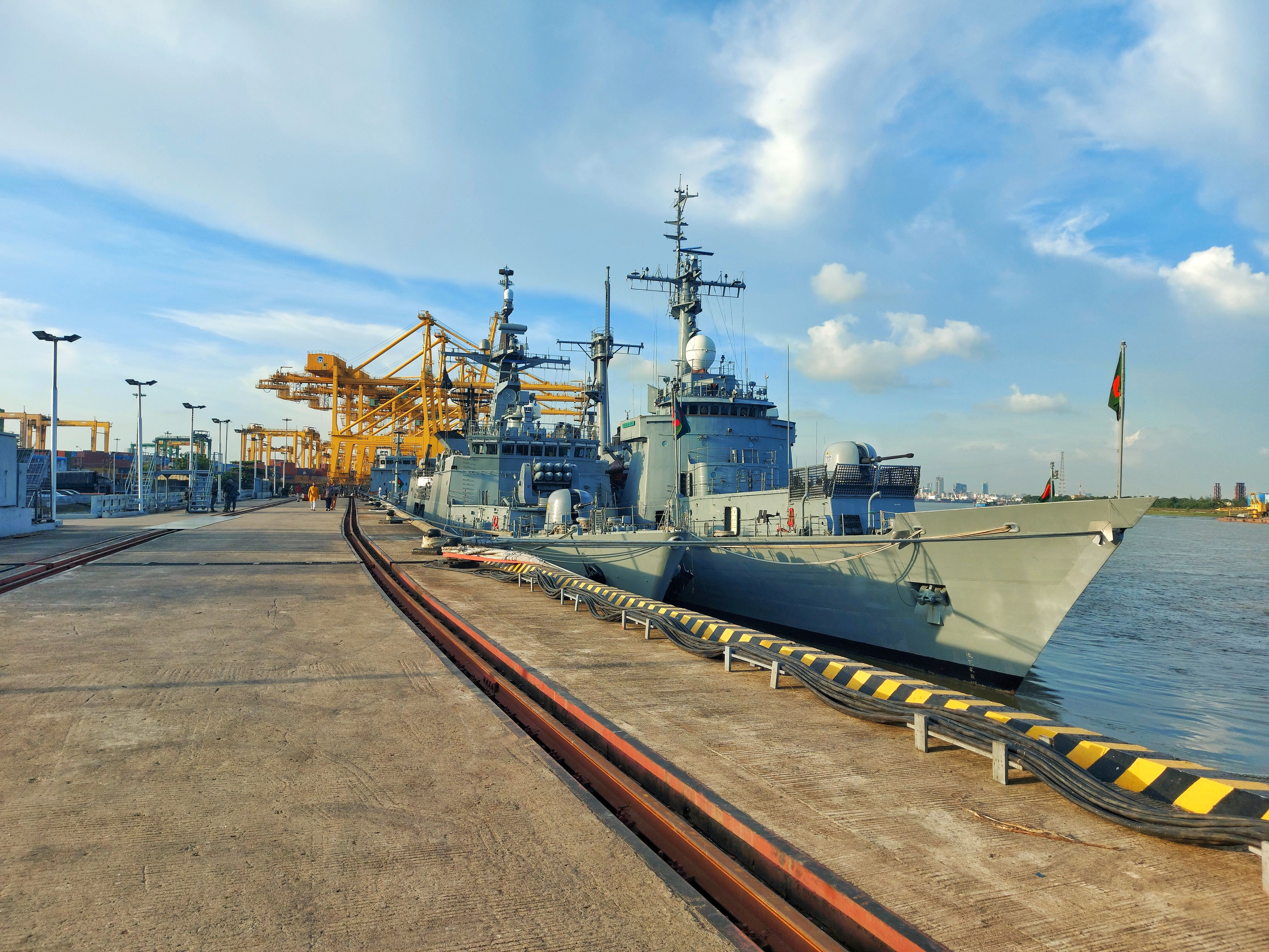 Military ships docked at urban harbor · Free Stock Photo