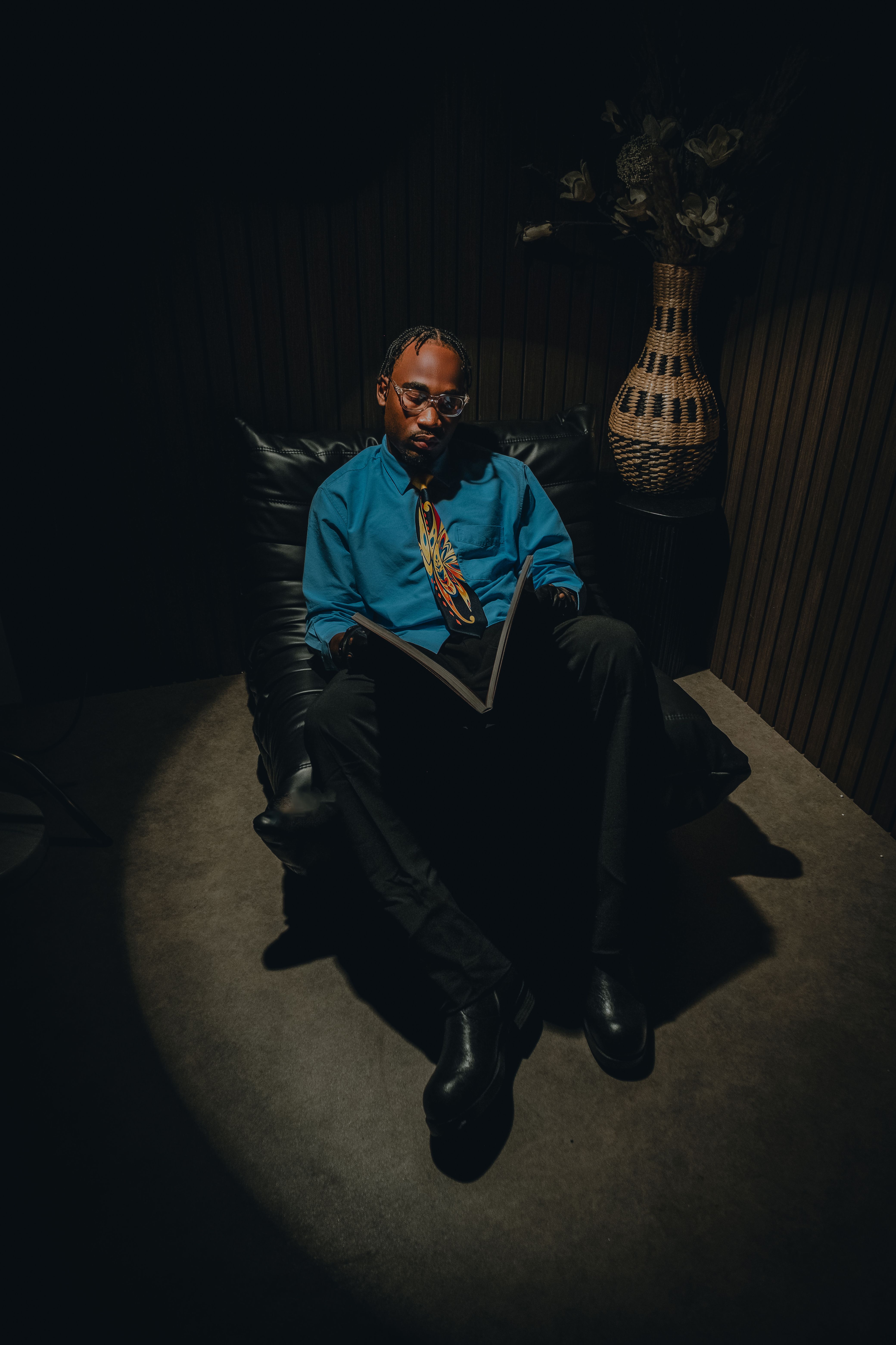 Moody Portrait of Man Reading in Dim Light · Free Stock Photo