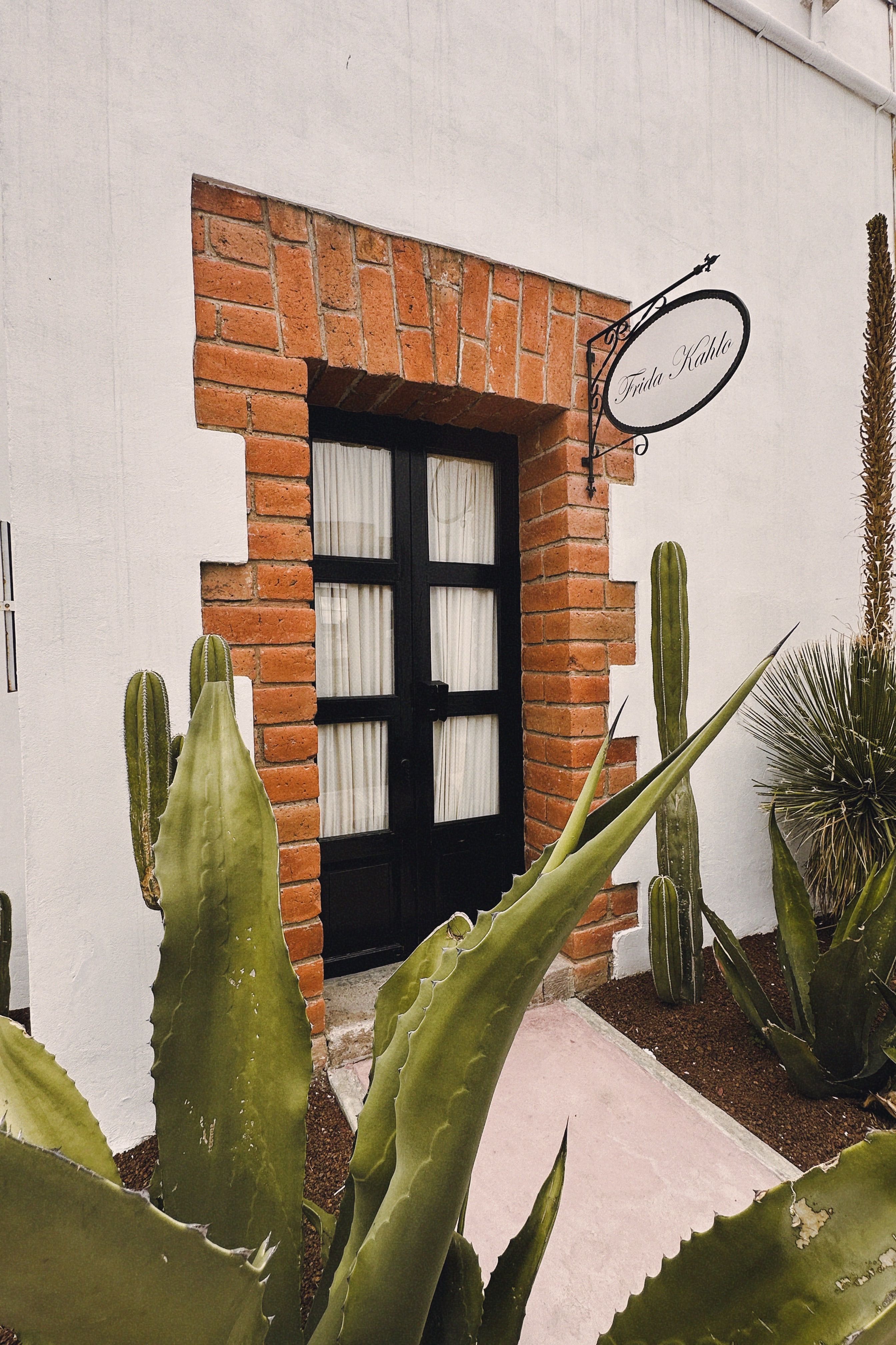 Rustic Brick Doorway with Desert Plants · Free Stock Photo