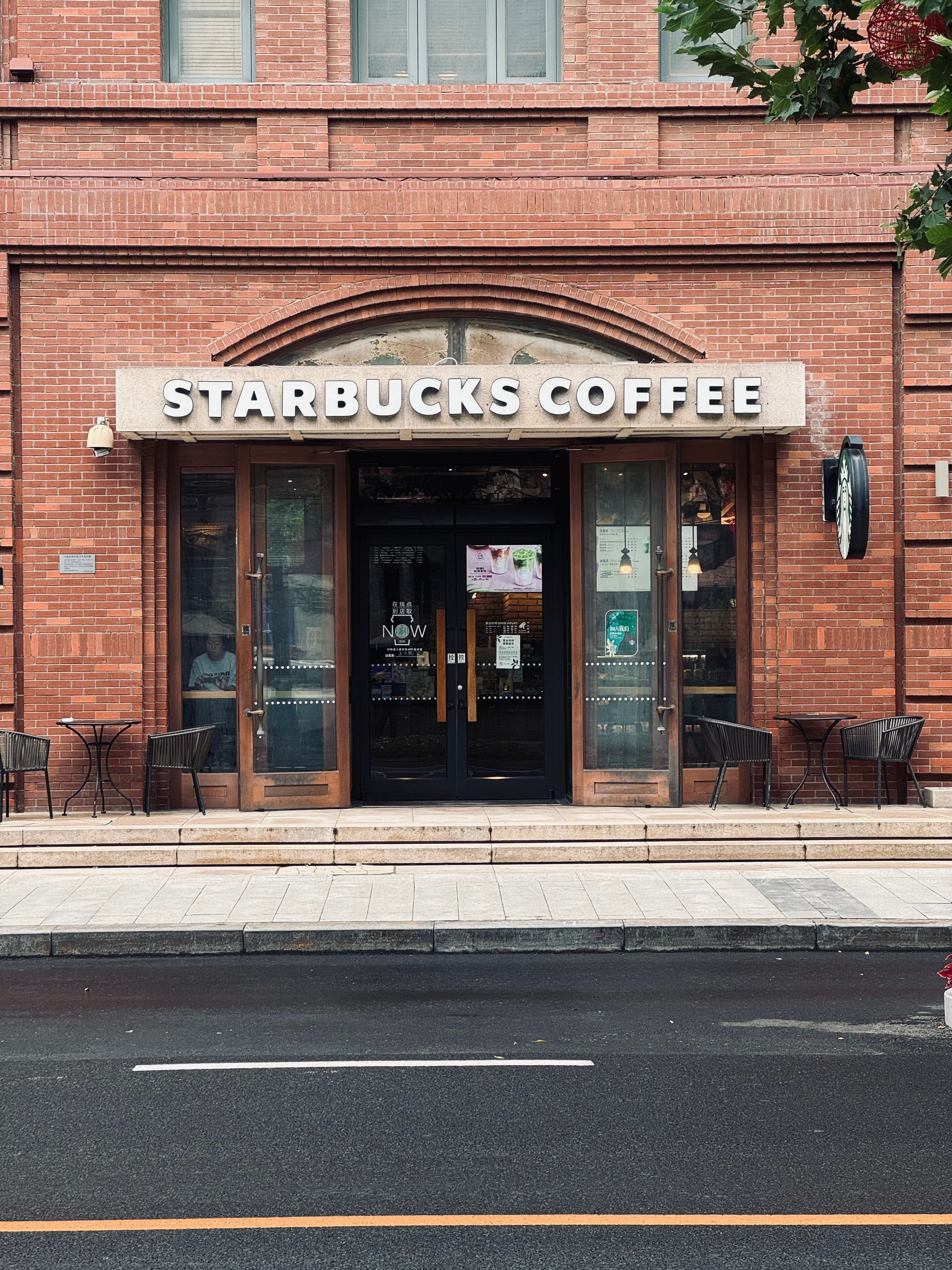 Exterior of Starbucks Coffee Shop with Brick Facade · Free Stock Photo