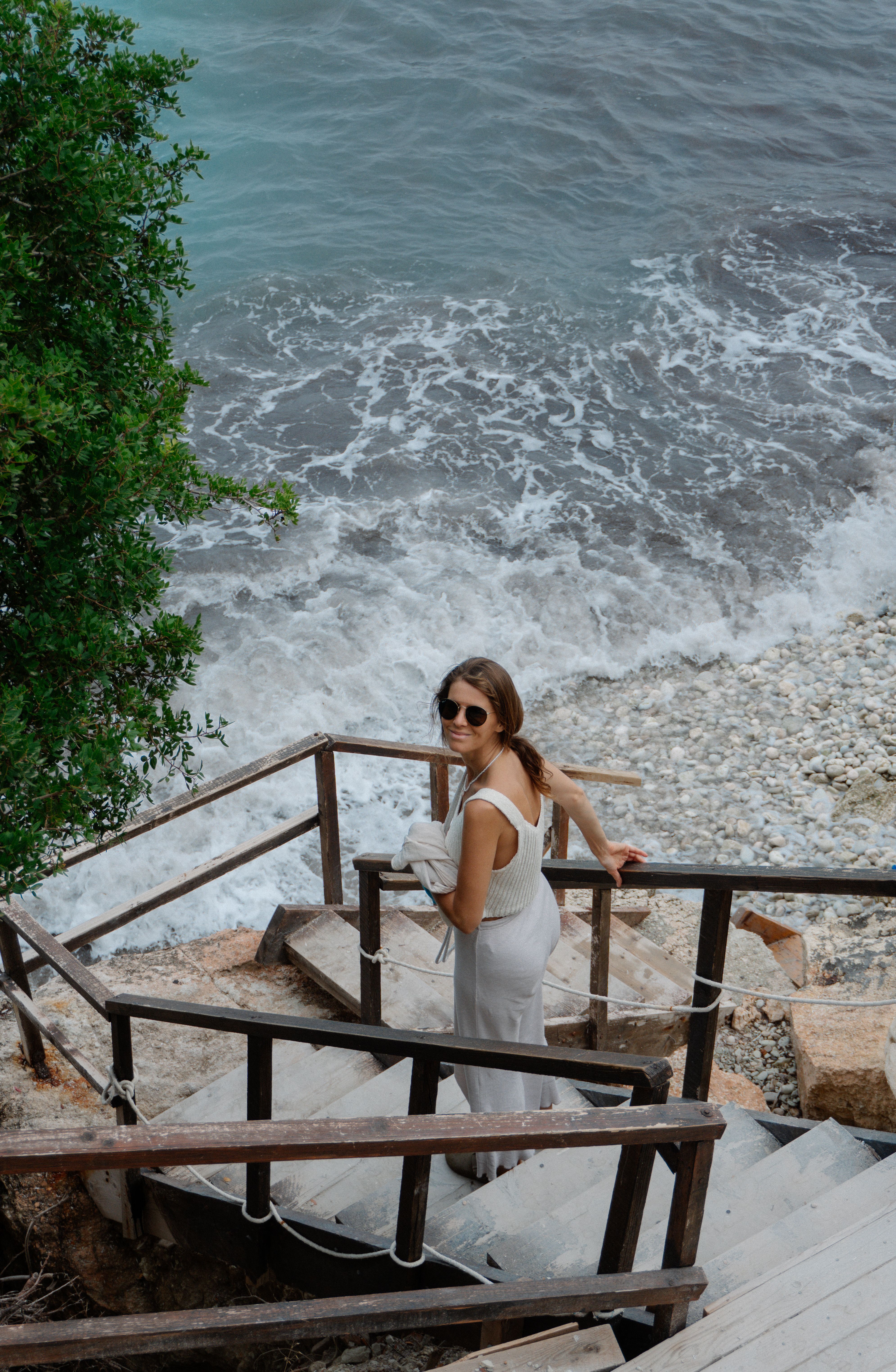 Woman Descending Coastal Staircase in Zakynthos · Free Stock Photo