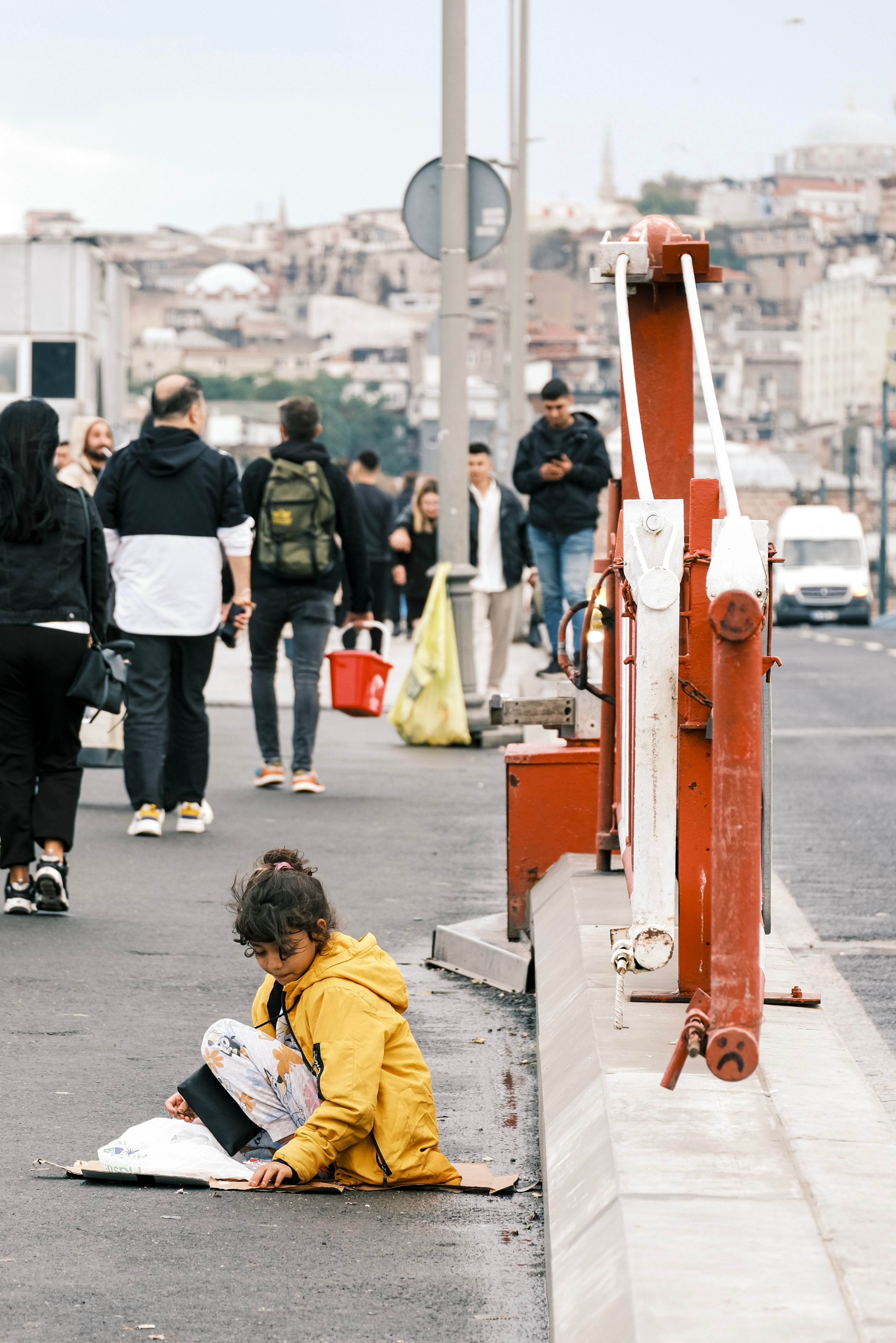 Street Scene with Child Drawing on Pavement · Free Stock Photo