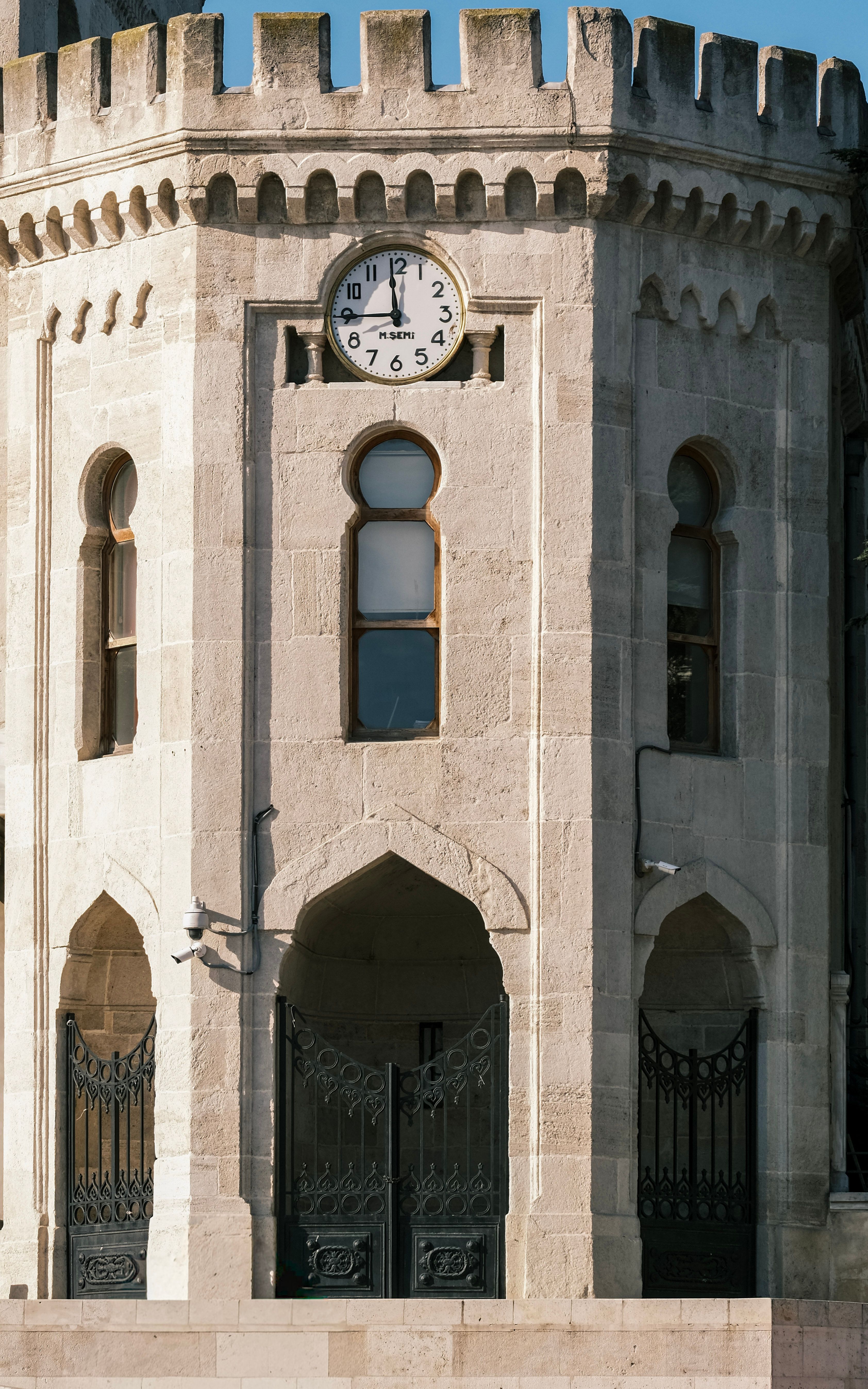 Historic Stone Clock Tower with Arched Windows · Free Stock Photo