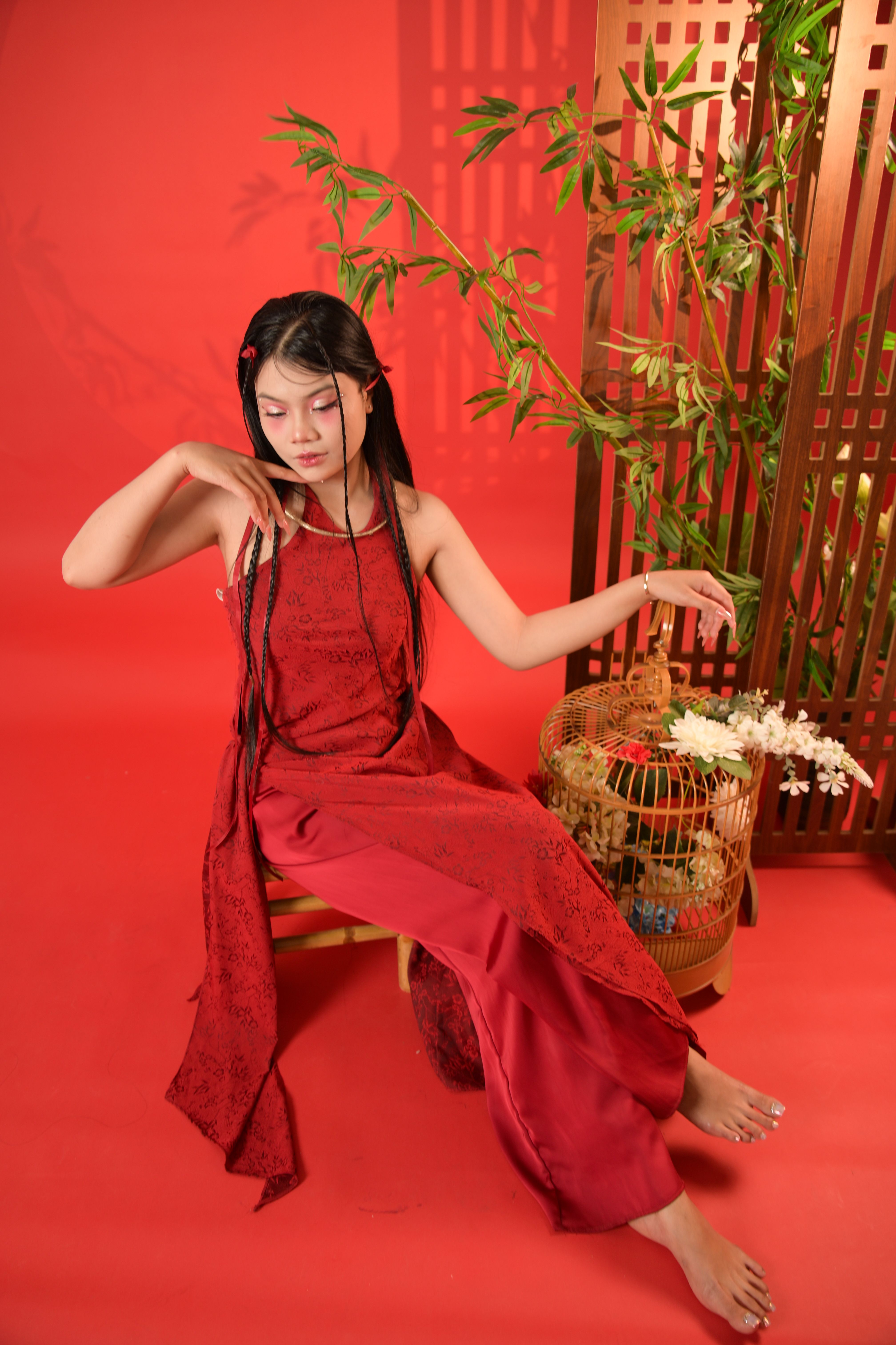 Elegant Woman in Traditional Red Dress with Bamboo · Free Stock Photo