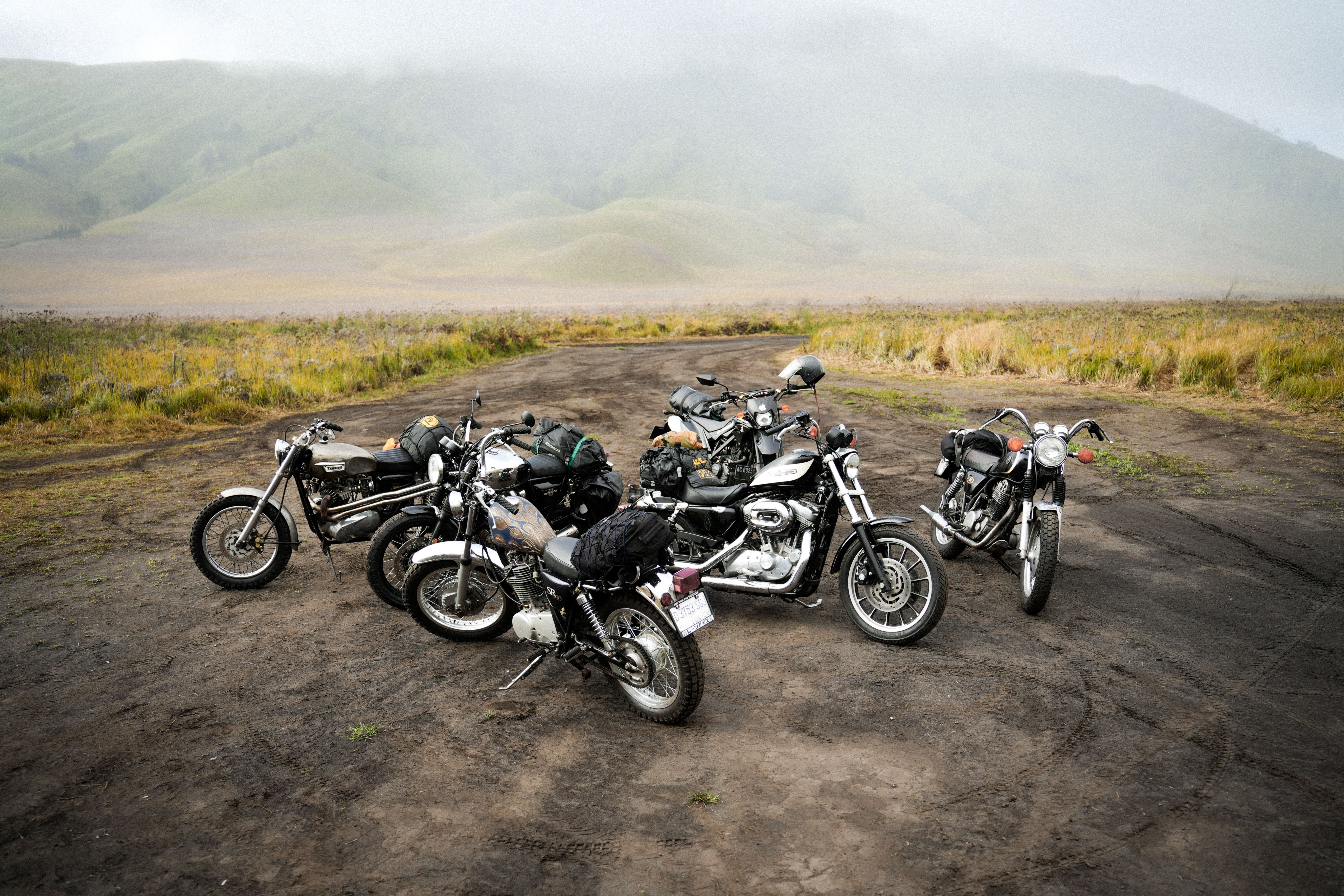Motorcycles Parked on Scenic Misty Landscape · Free Stock Photo