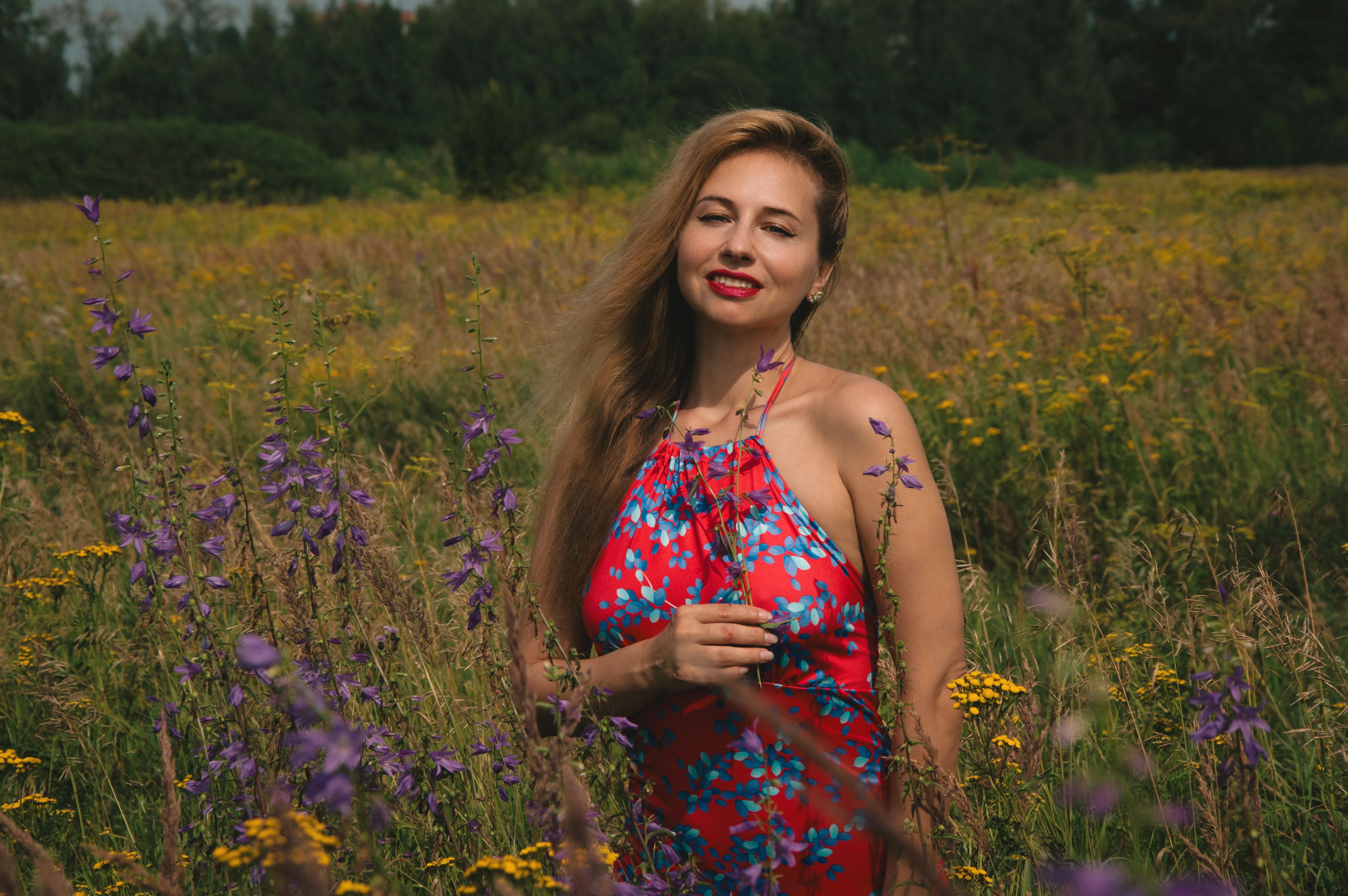 Woman in Floral Dress in a Vibrant Wildflower Field · Free Stock Photo