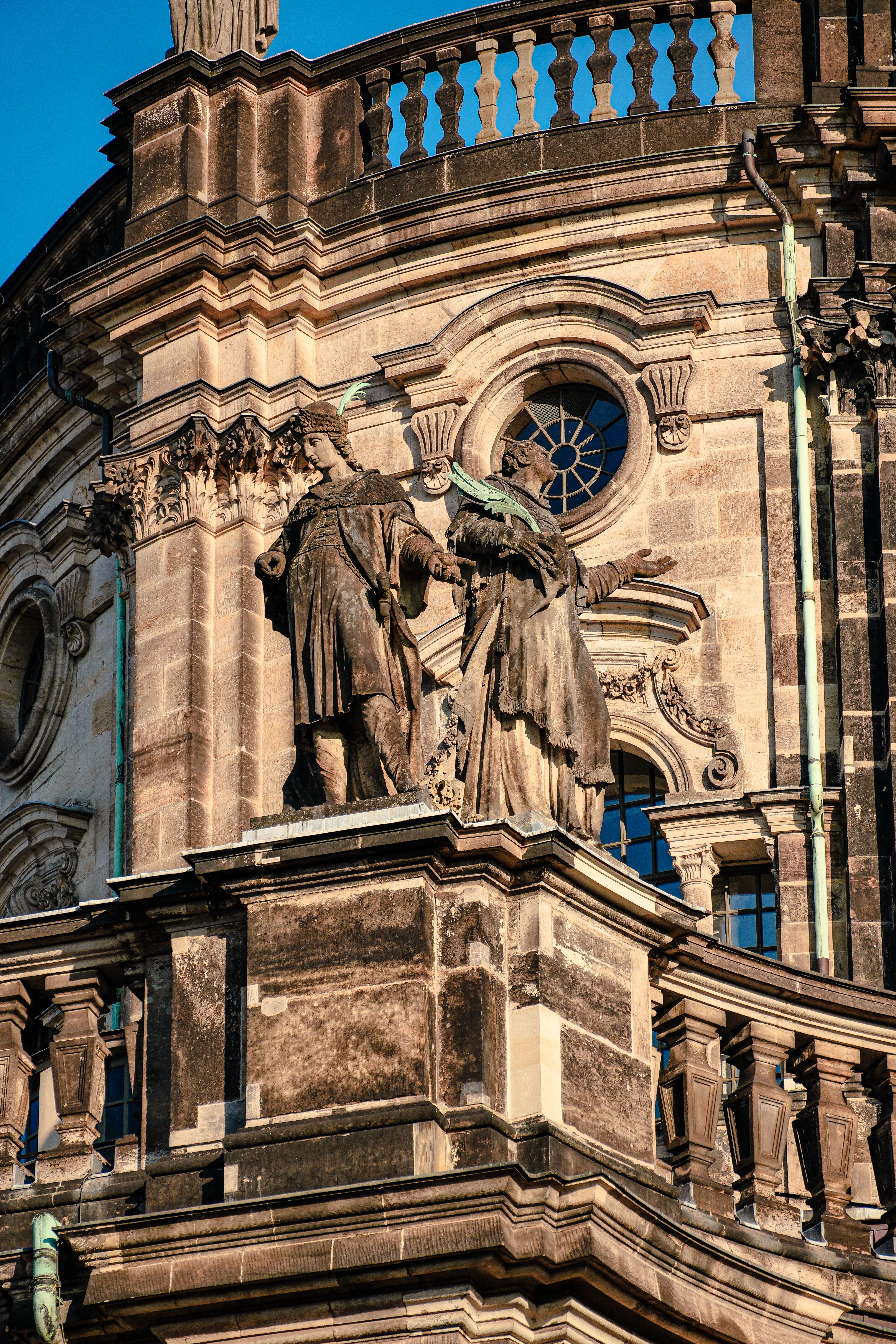 Weathered Stone Statues on Historic Building Façade · Free Stock Photo