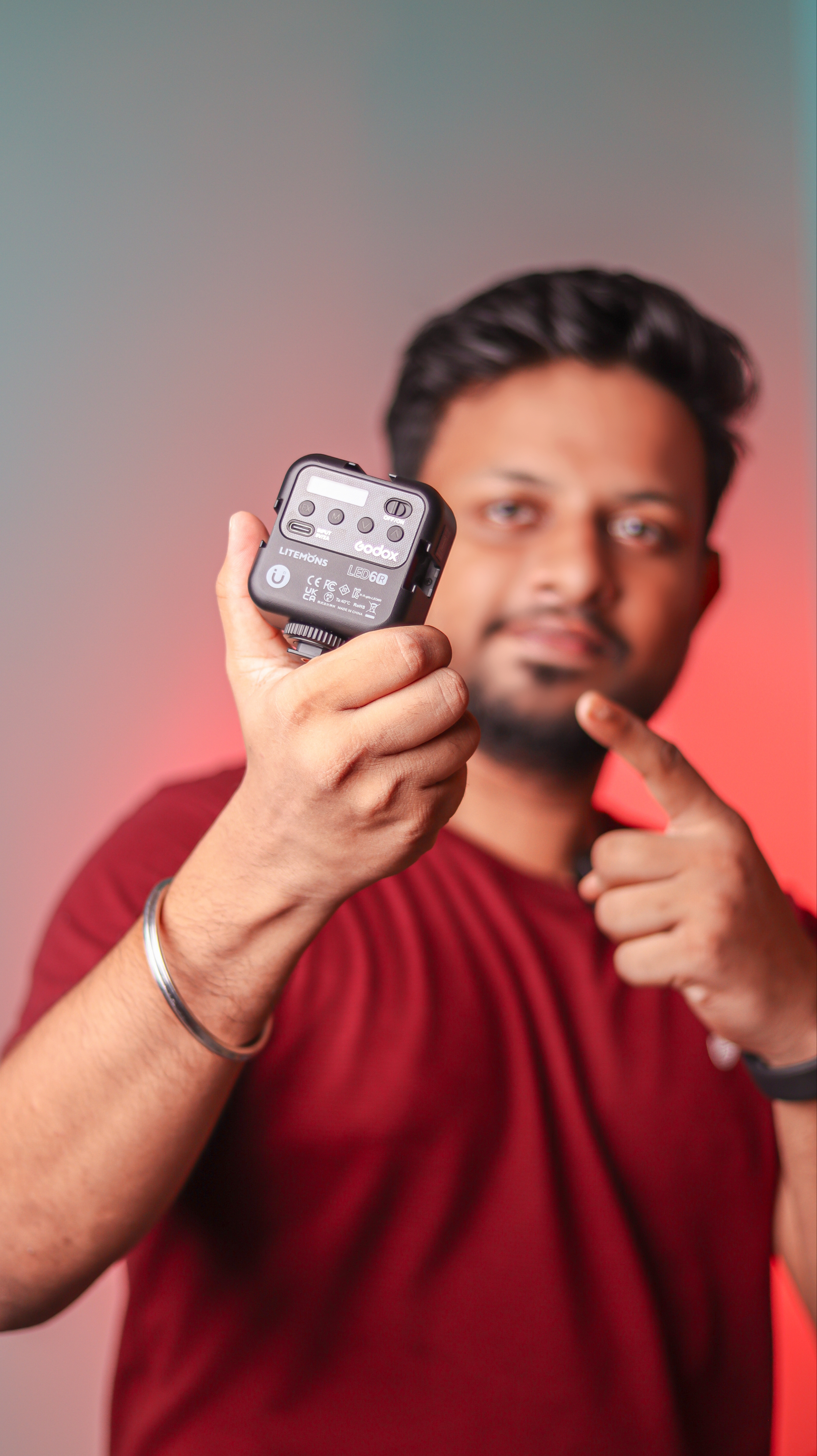Man Displaying a Compact Electronic Device · Free Stock Photo